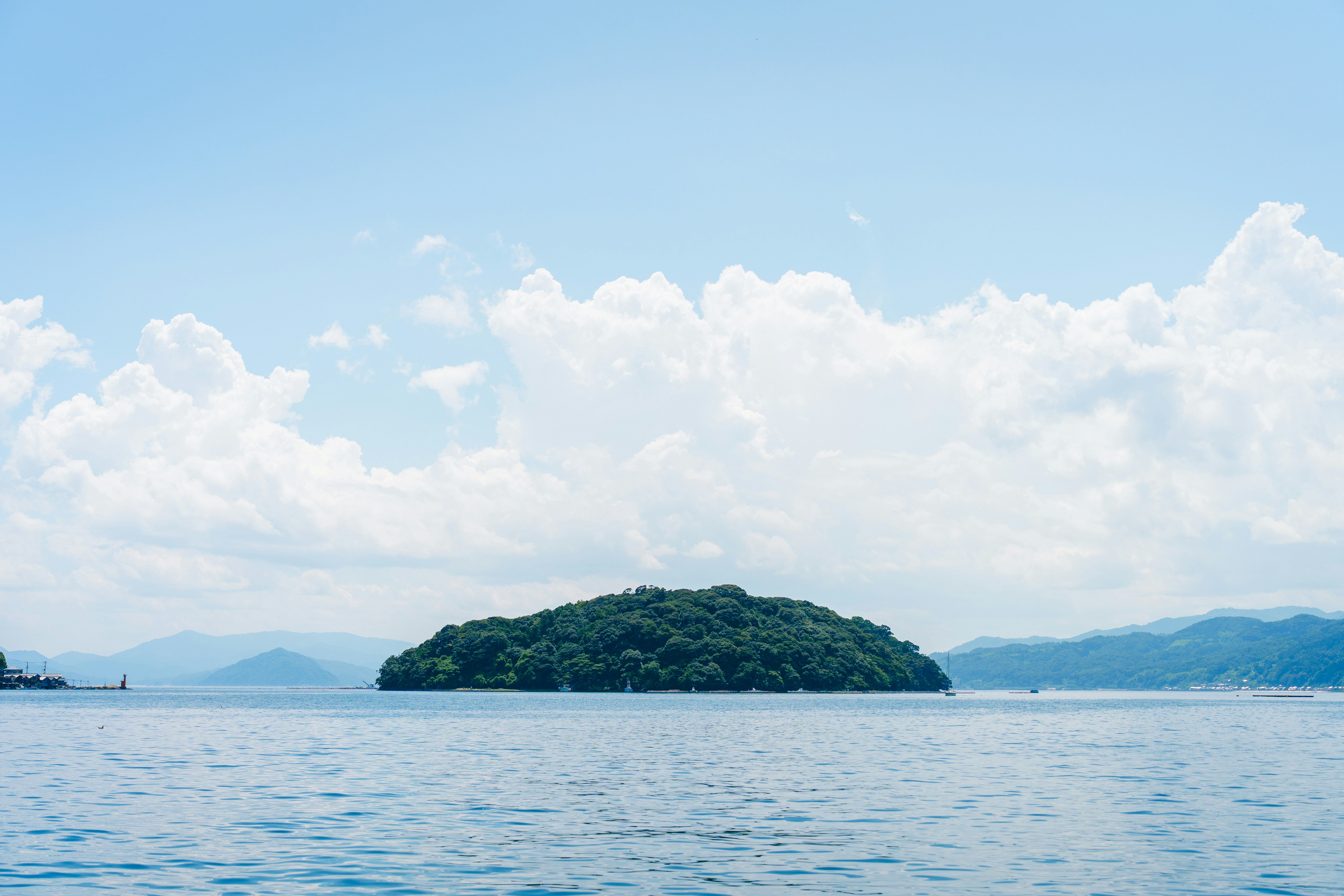 An island sits peacefully in the ocean.