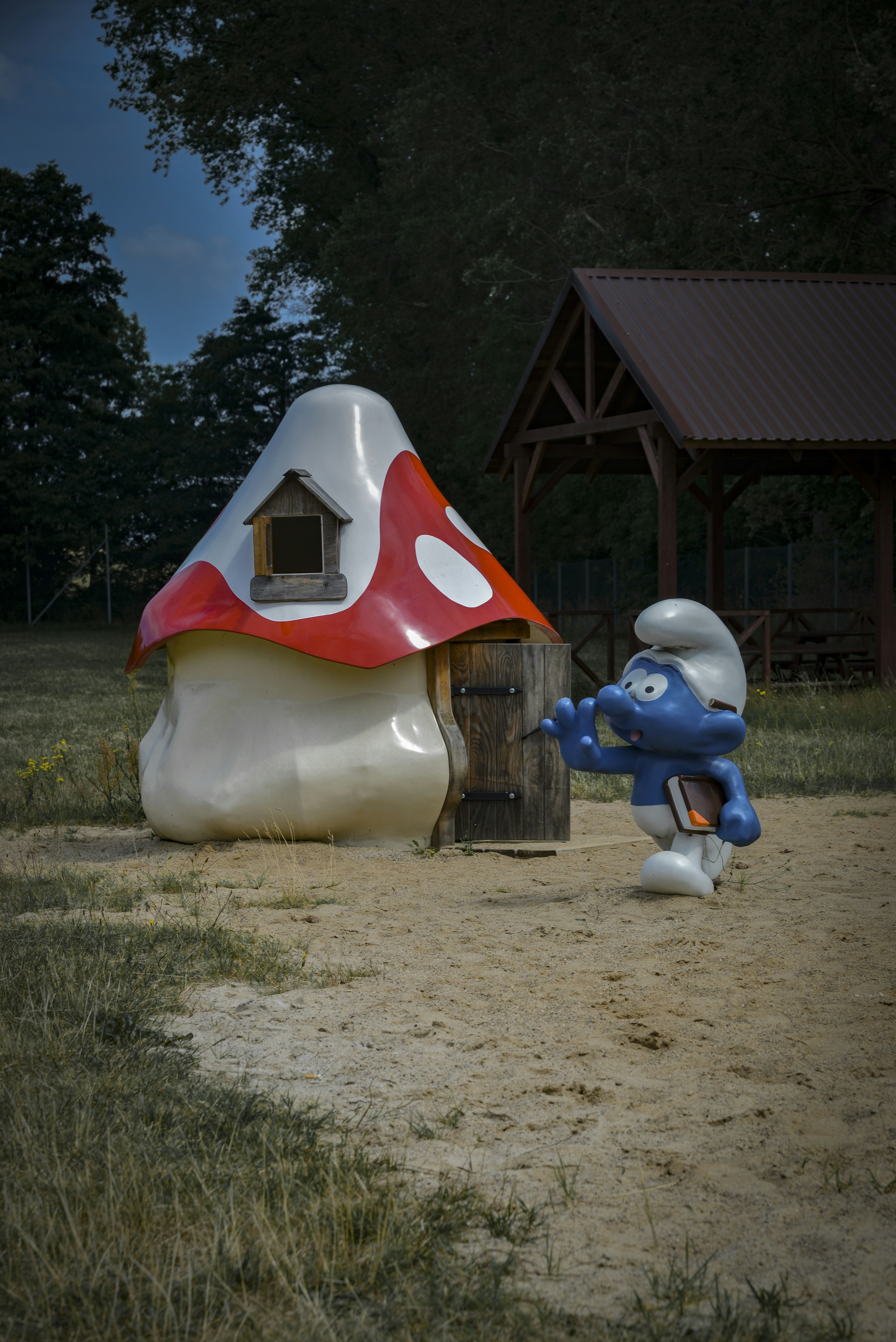 A smurf stands by a mushroom-shaped house. photo – Free Forest Image on ...