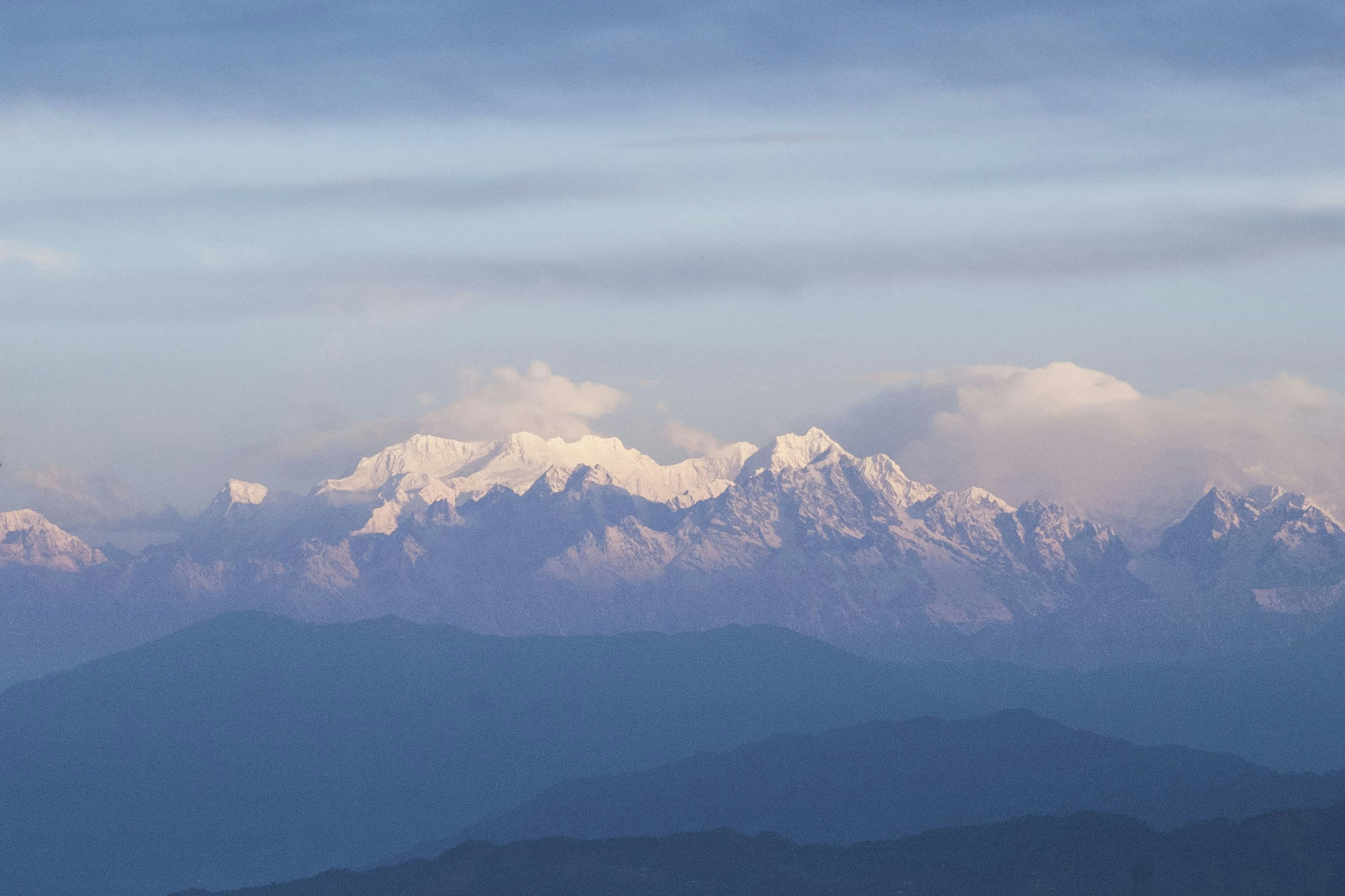 View on Himalaya | Snow-capped mountains under a beautiful, cloudy sky.