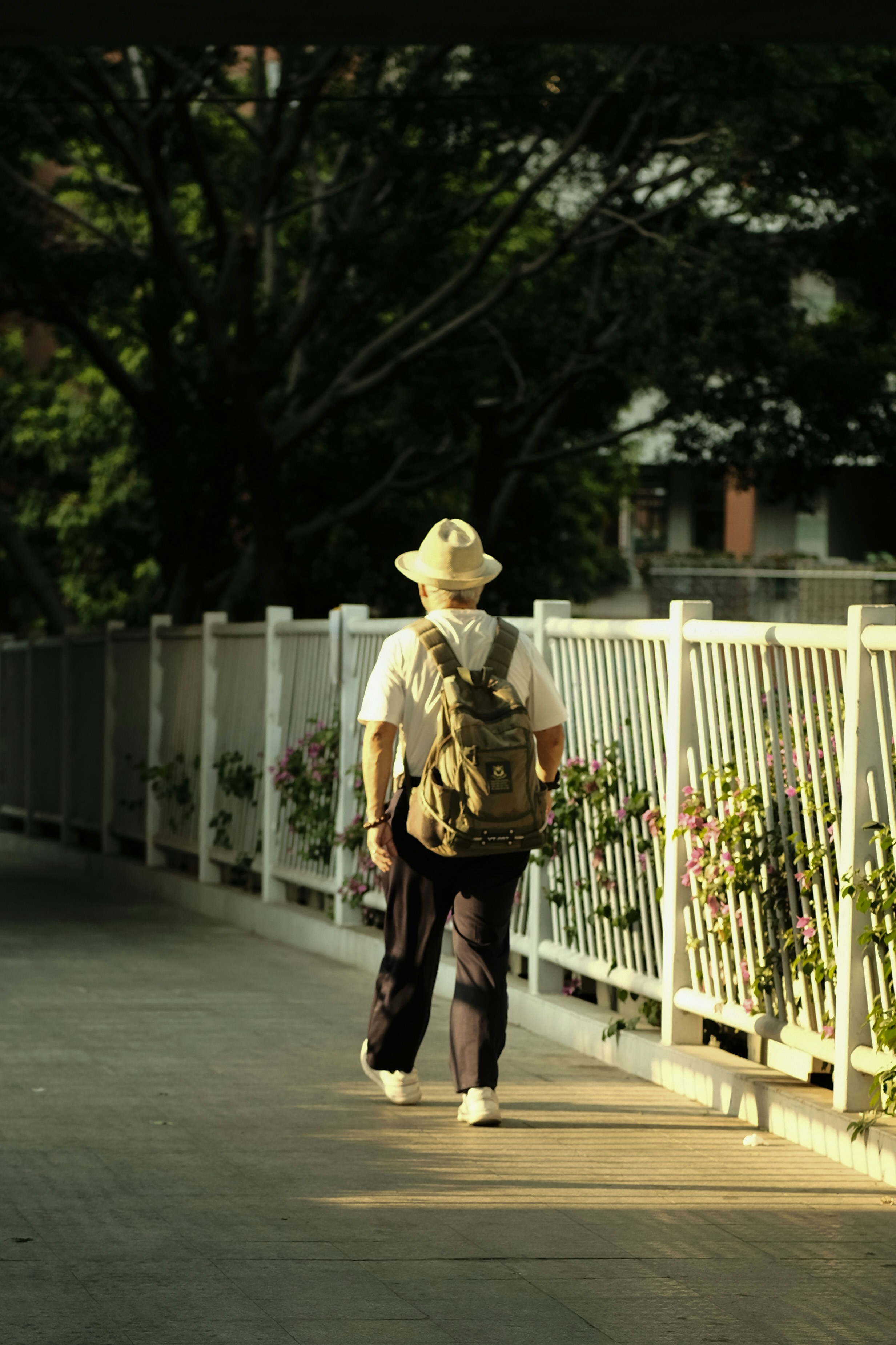 A person walks along a bridge, away from view.