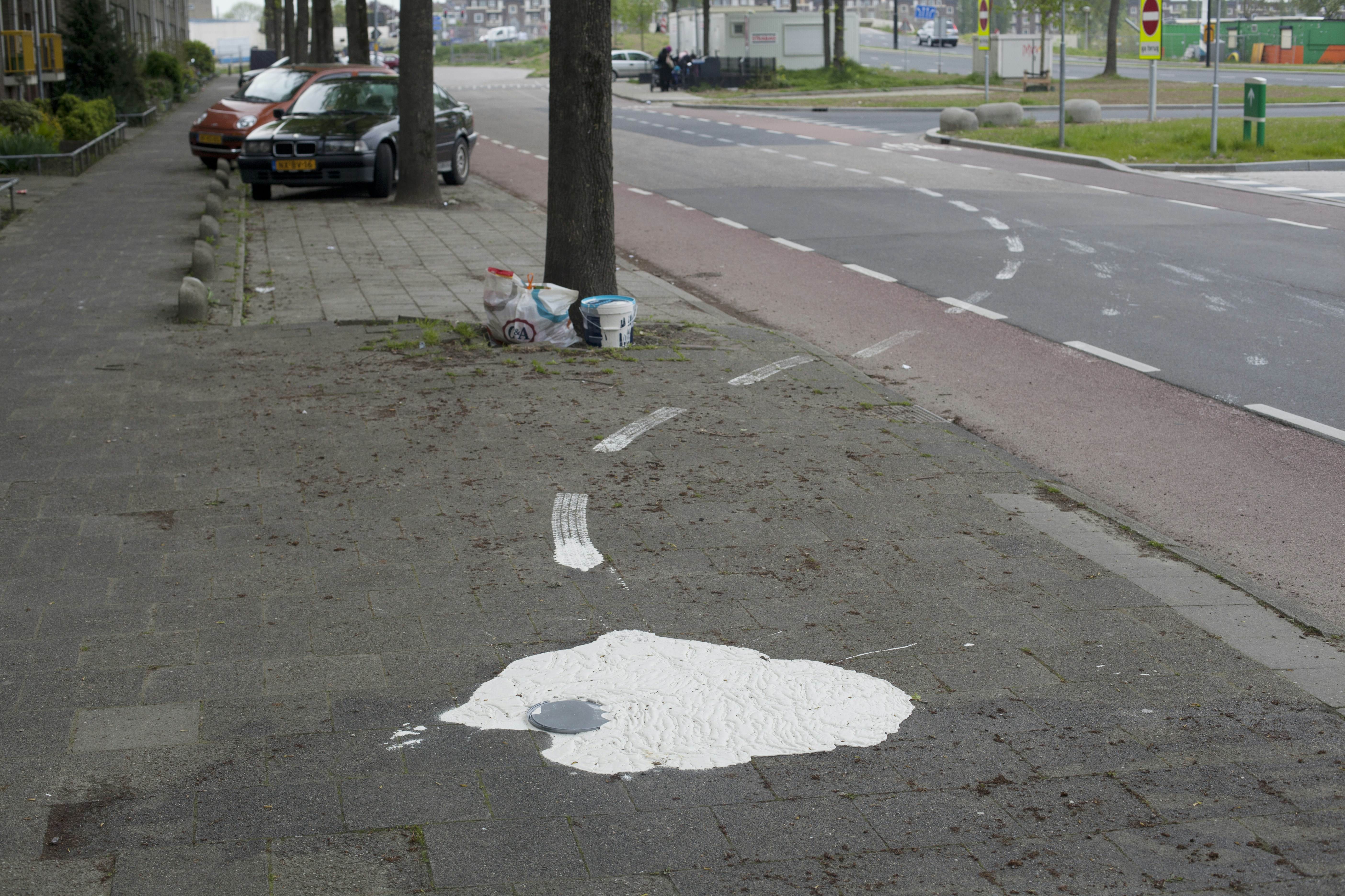 Pale Puddle on the Sidewalk: Quiet Urban Focus