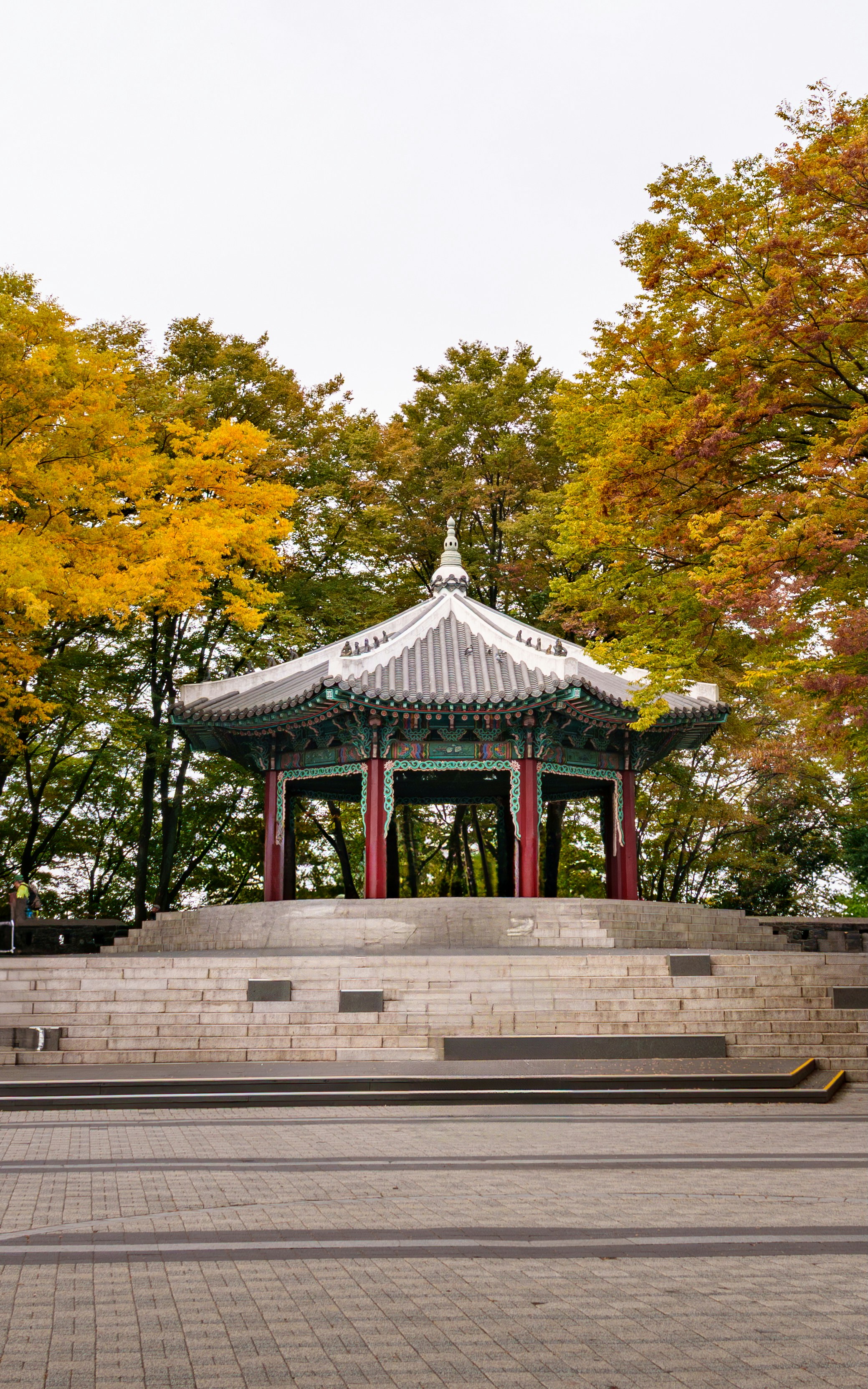 Harmony in Autumn: A Cultural Pavilion Amidst Golden Foliage