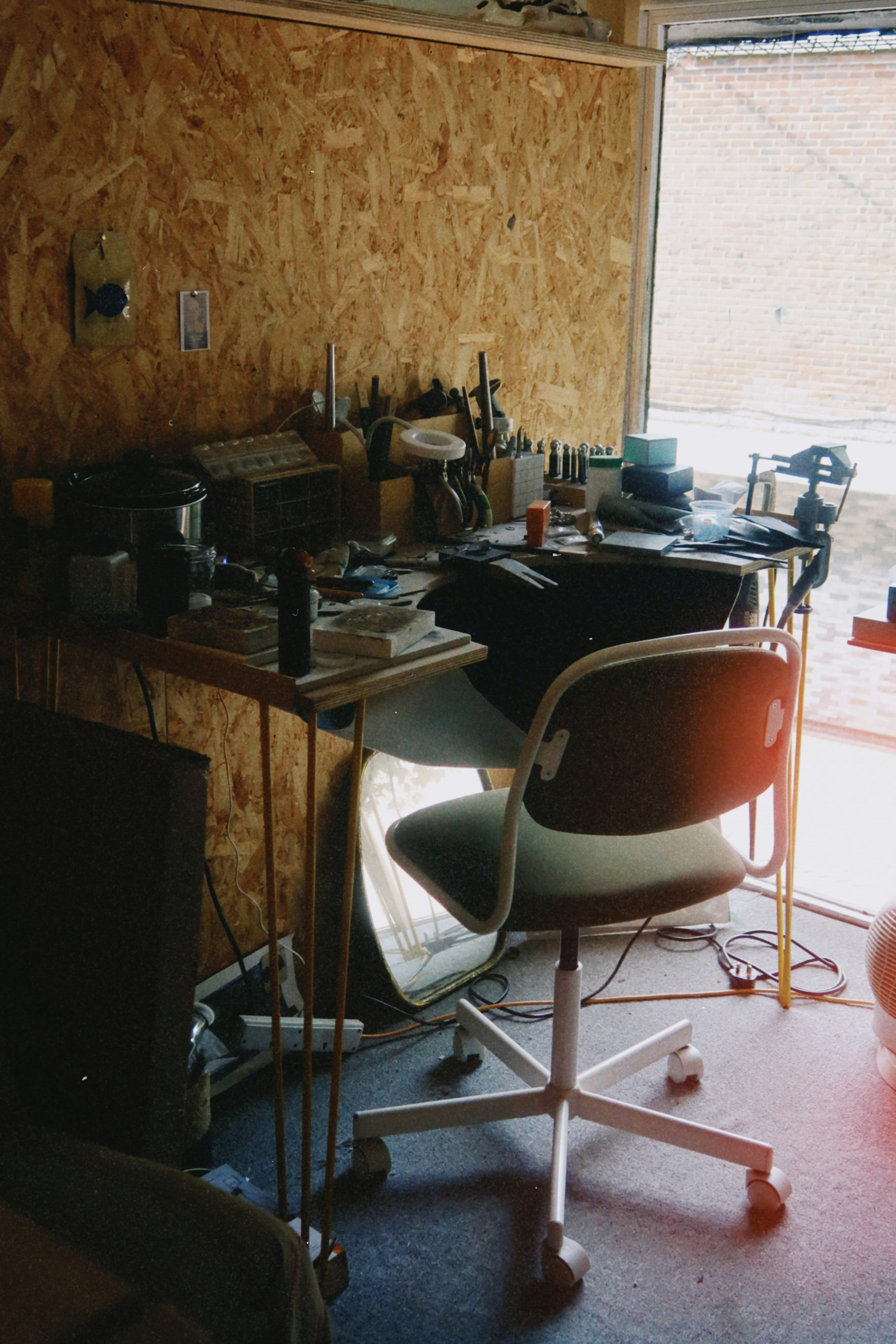 A cluttered workstation with a modern chair. photo – Free Interior ...