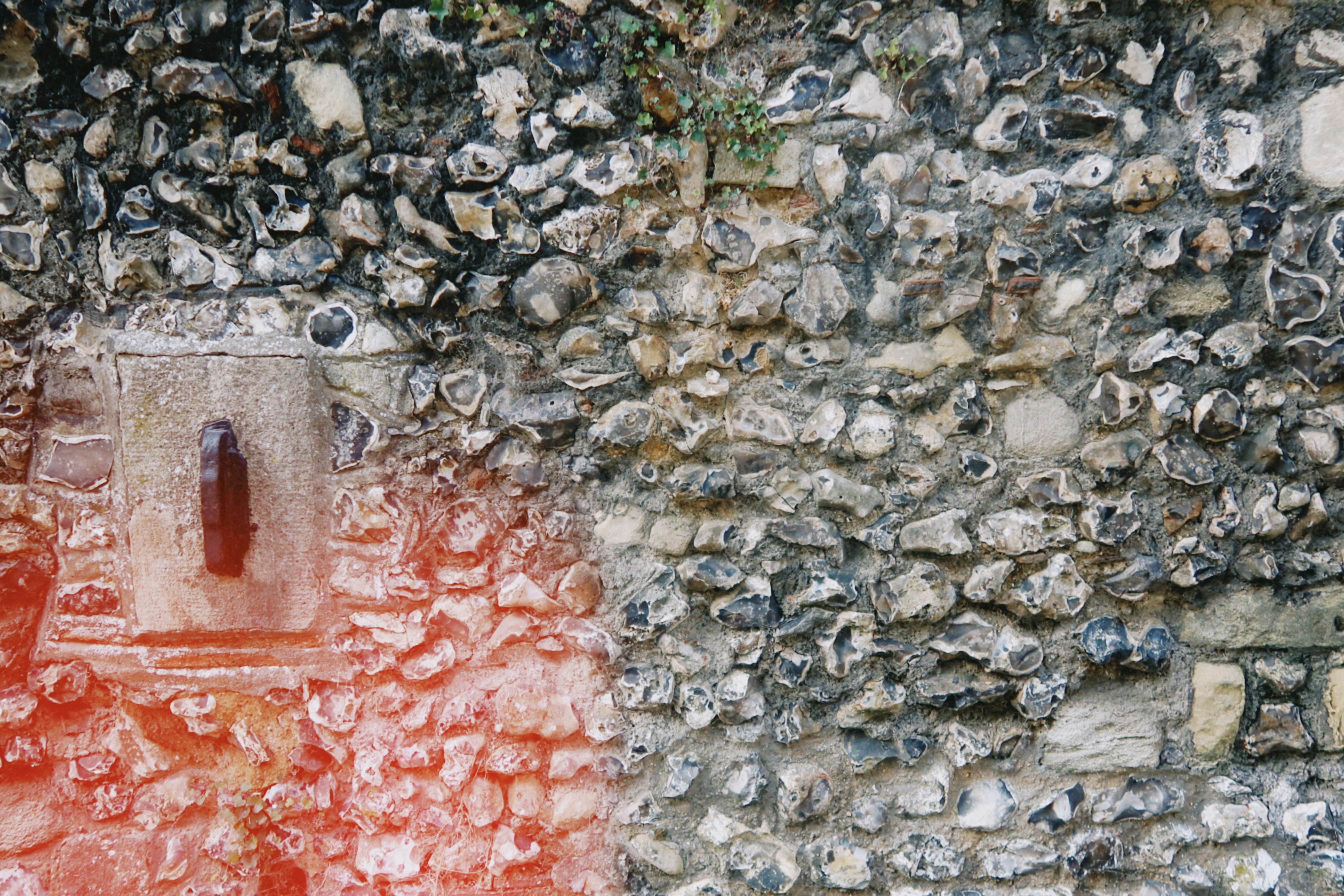 A stone wall with an antique feature.