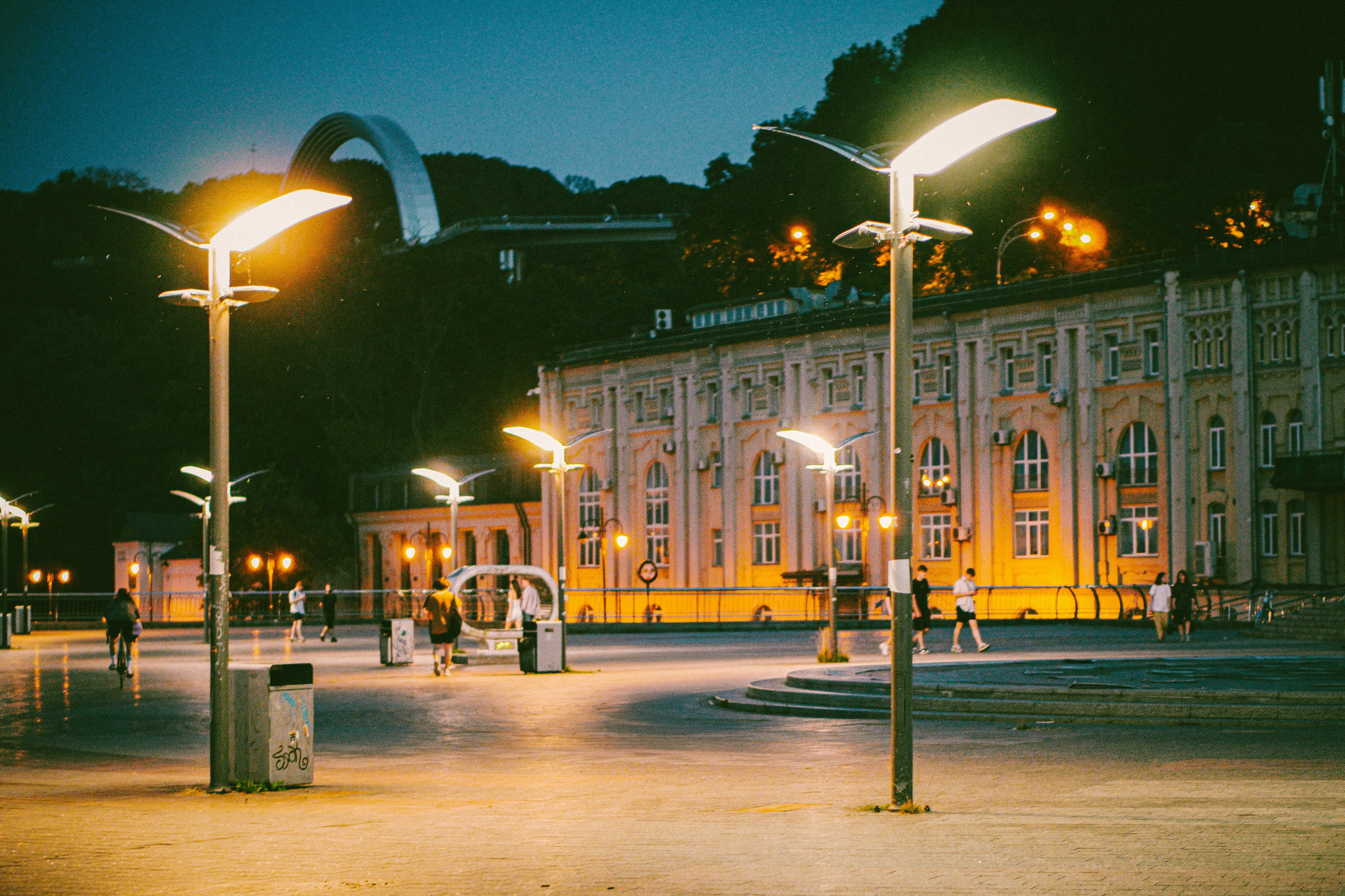 Evening view of a city with lit streetlights.