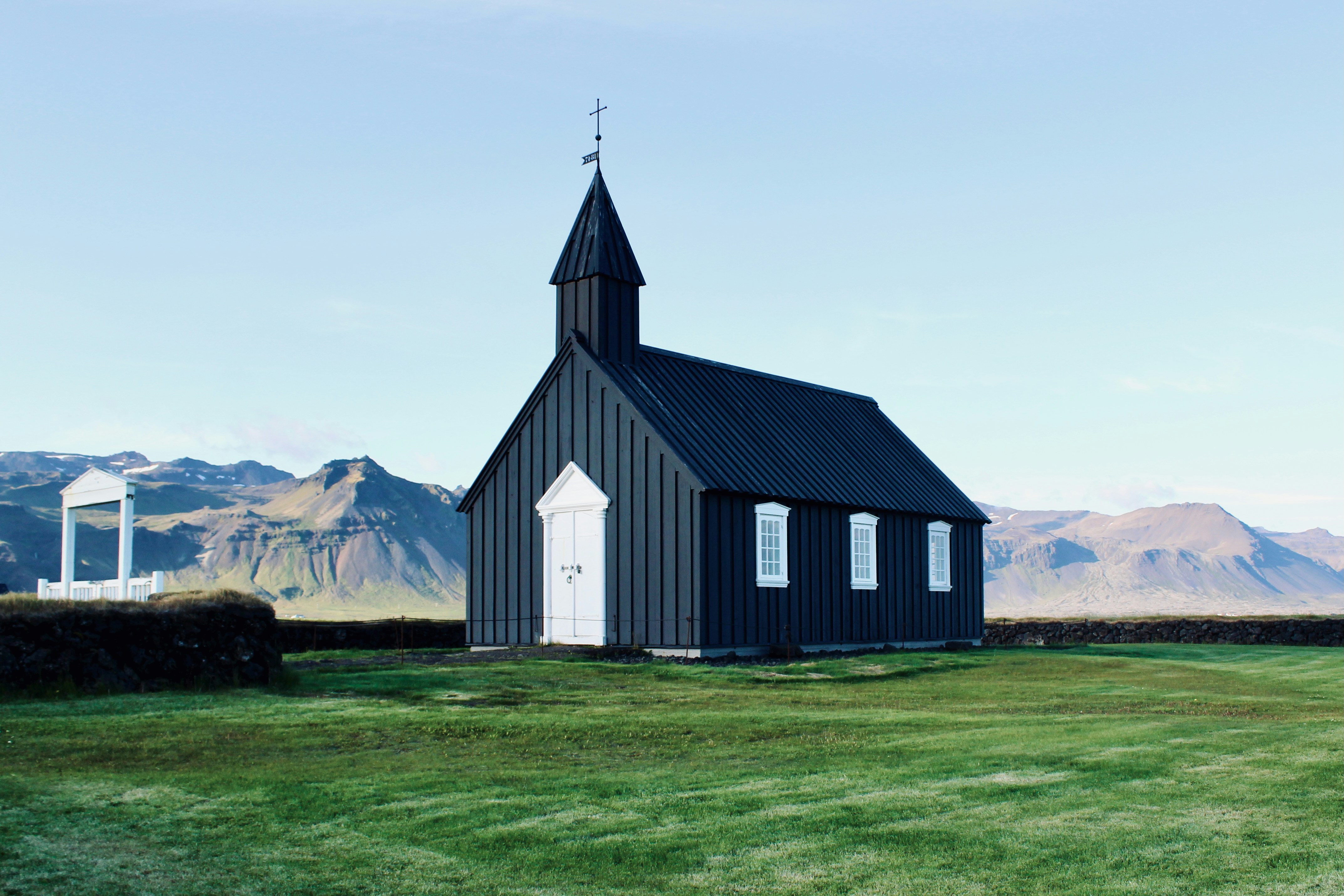 Black Church, Budakirkja, Iceland | A black church stands in a field.