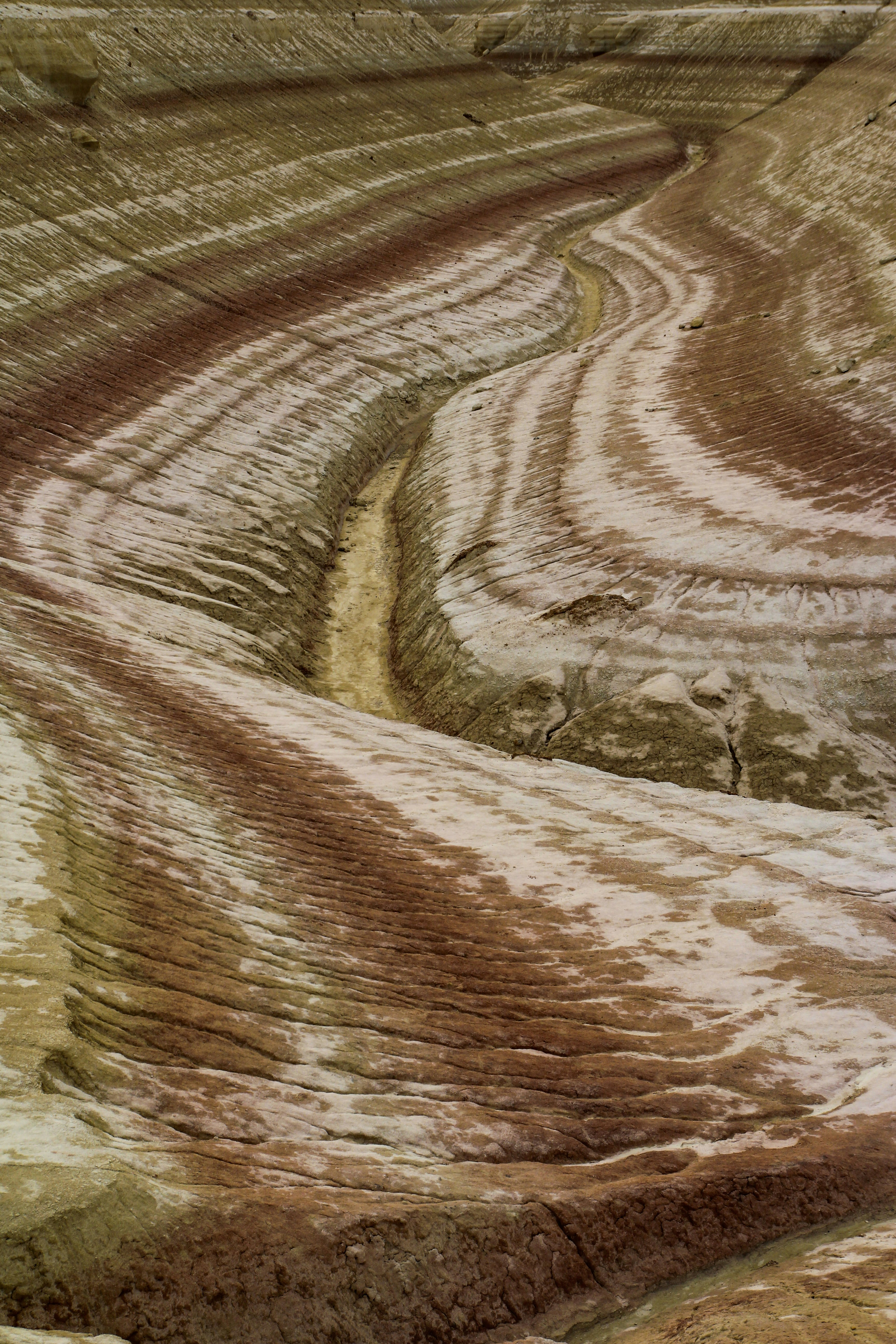 Colorful layered rock formations create a winding landscape.