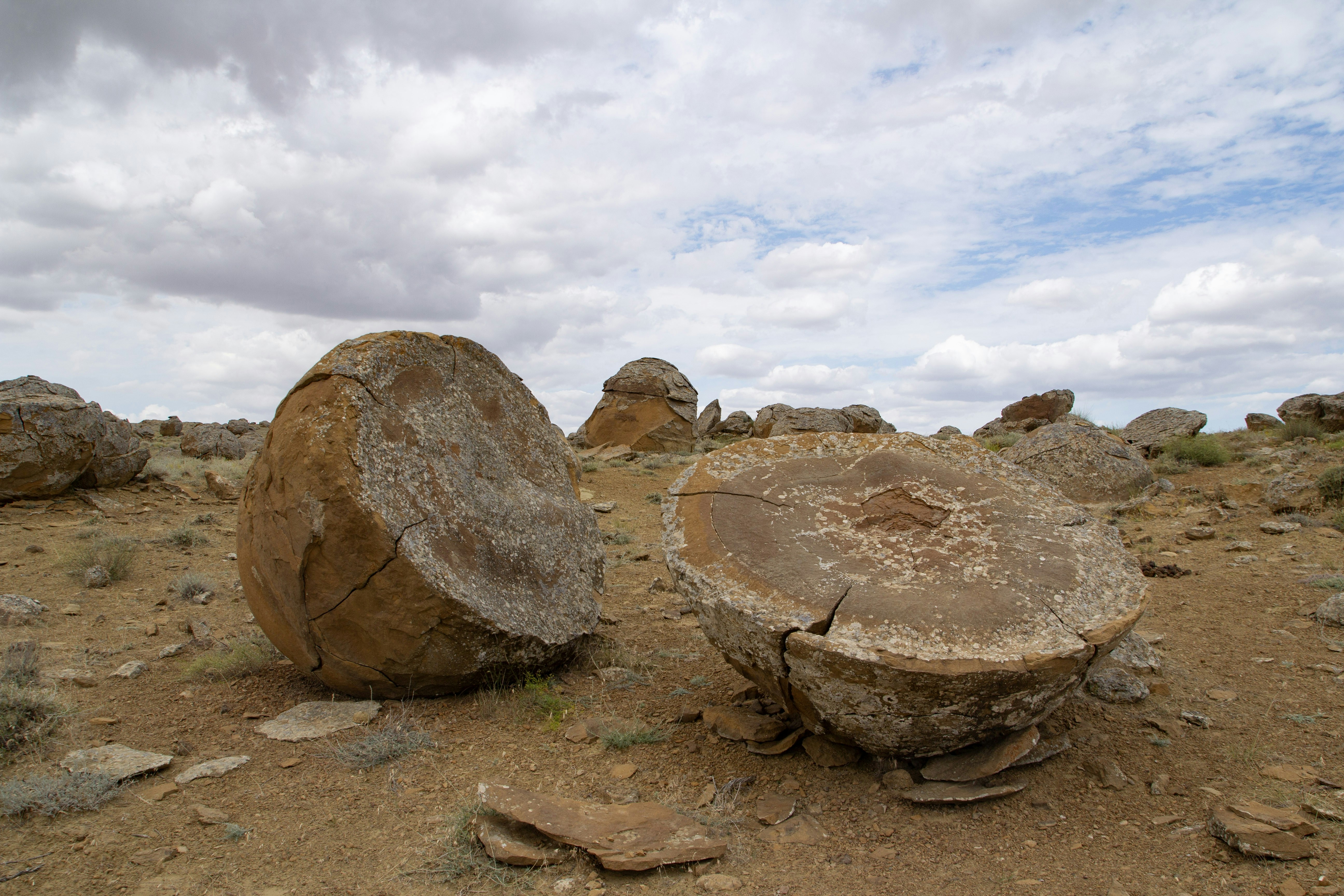 Split rocks sit in a desert landscape.