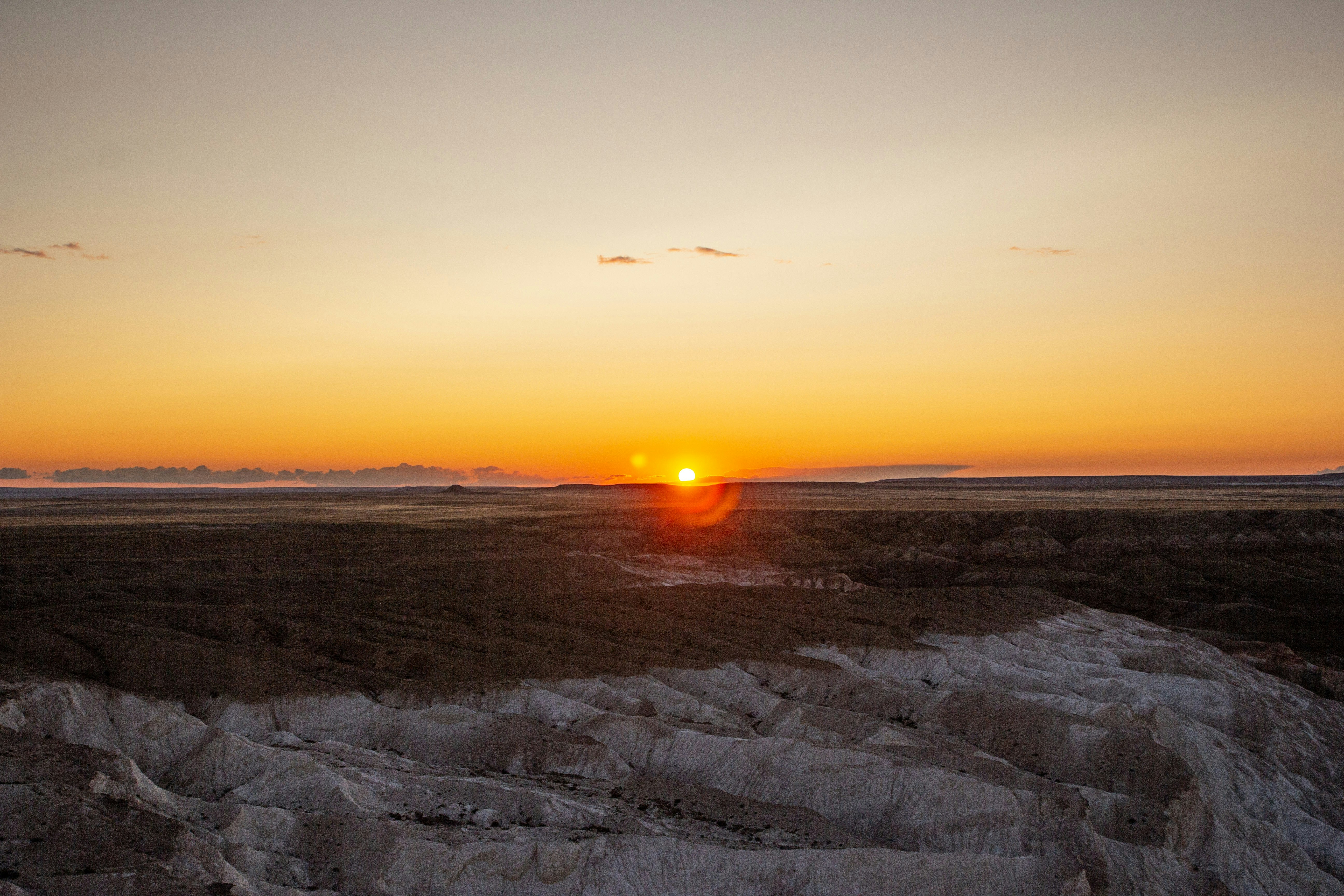 Whispers of the Setting Sun Over Arid Terrain