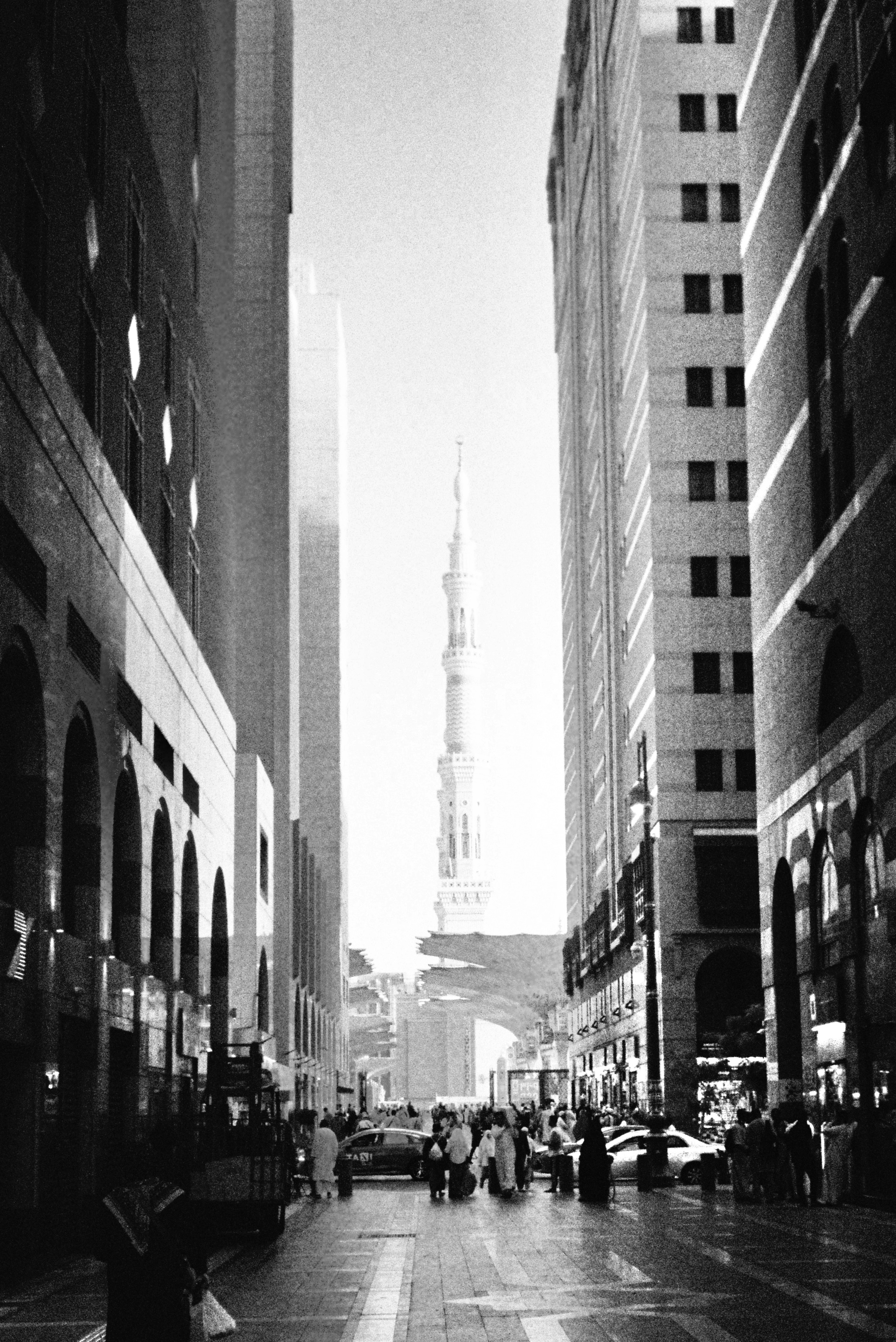 A street leads to a towering minaret.