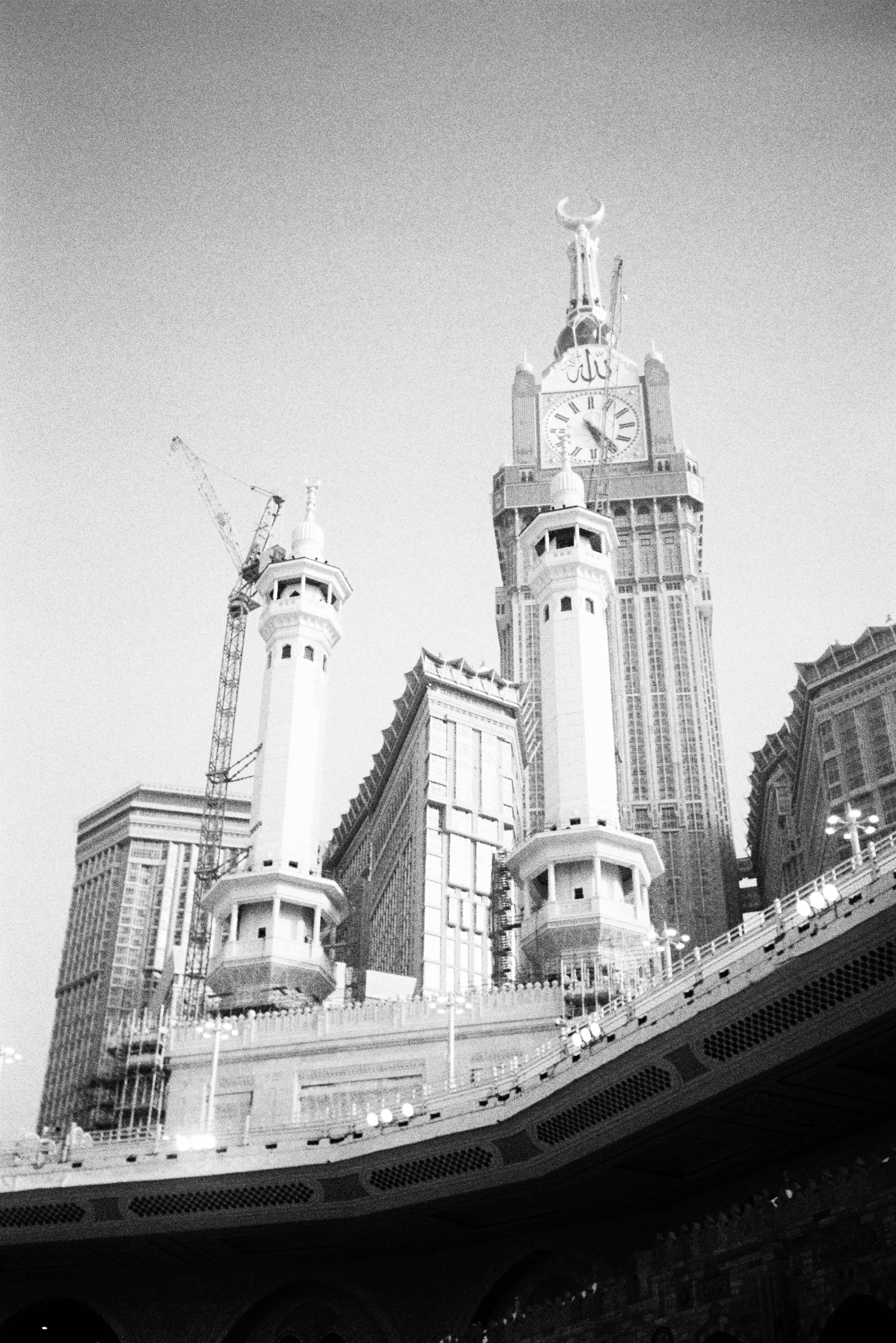 Clock tower and minarets rise in mecca.