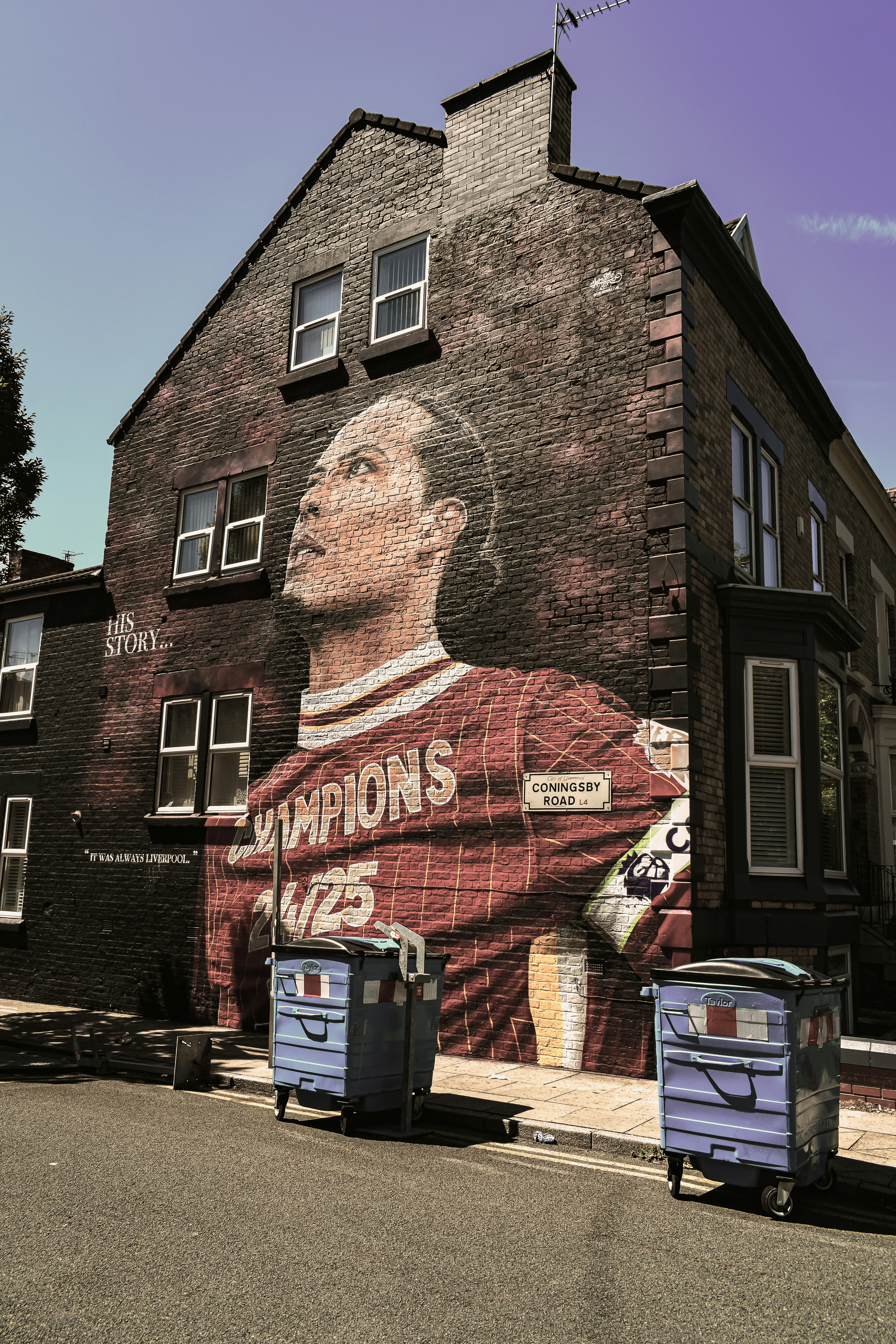 A mural of virgil van dijk on a building.