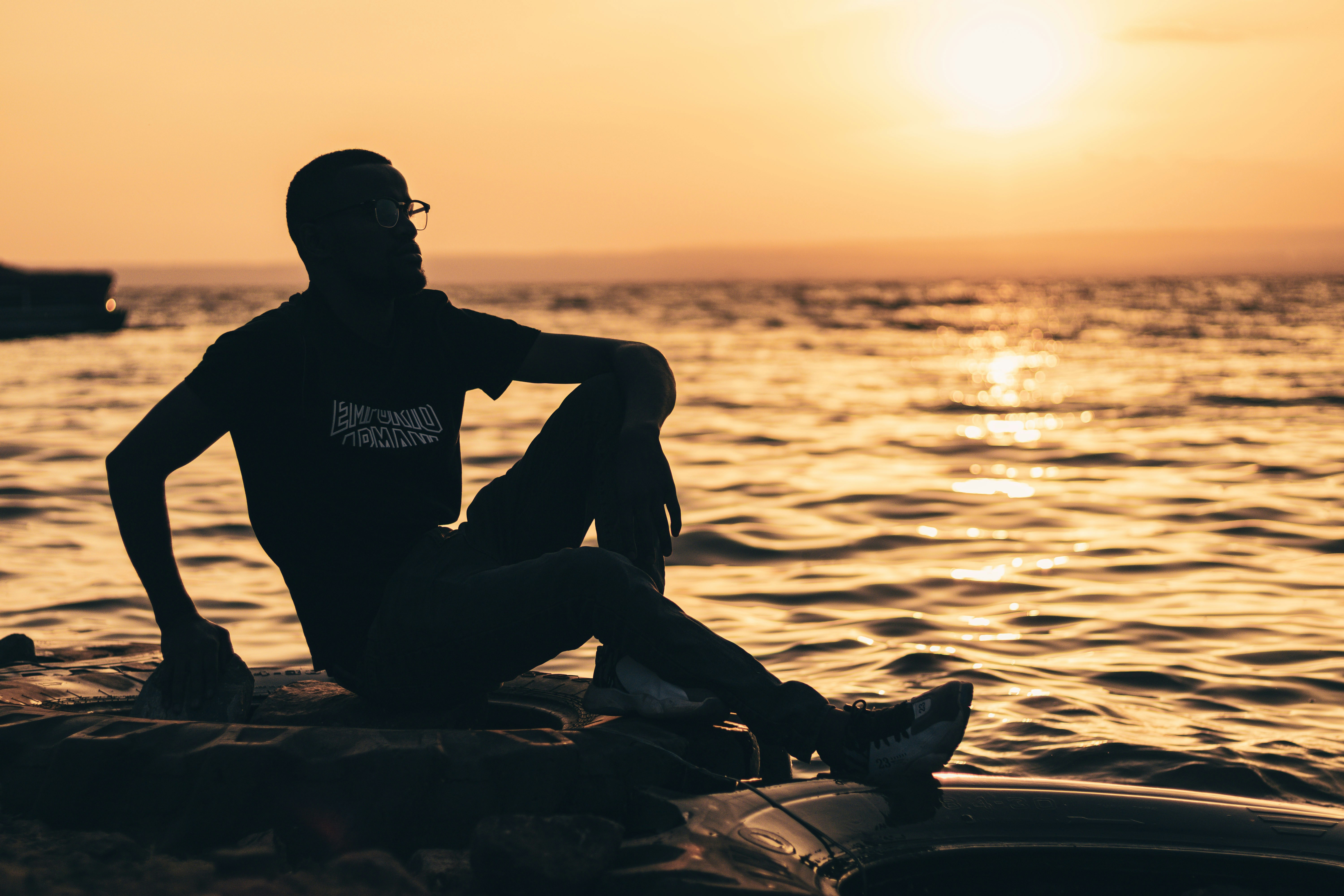 Solitary silhouette at the water's edge during sunset