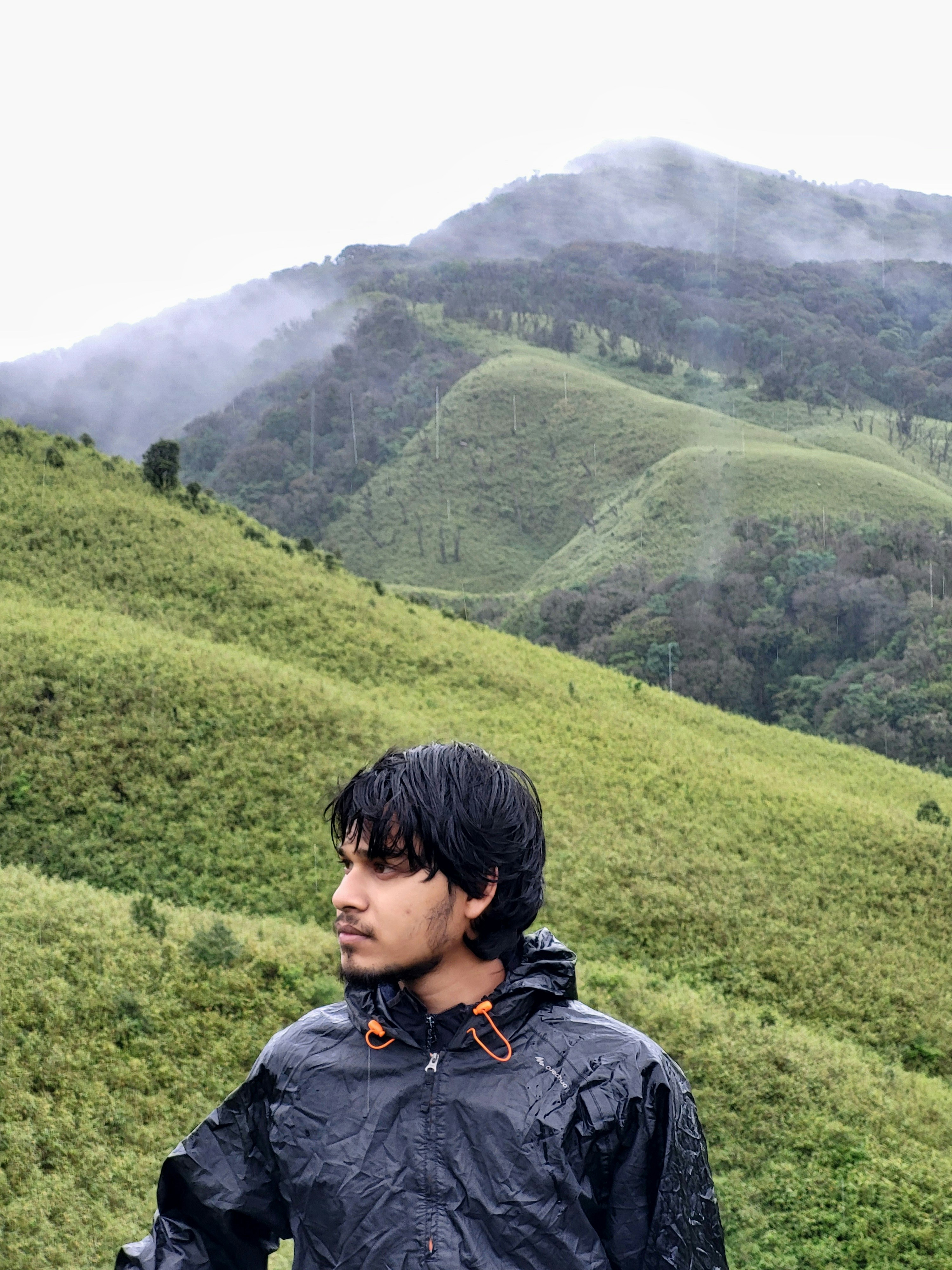 Mist-Wrapped Ridge Portrait: A Wanderer on a Quiet Green Ascent