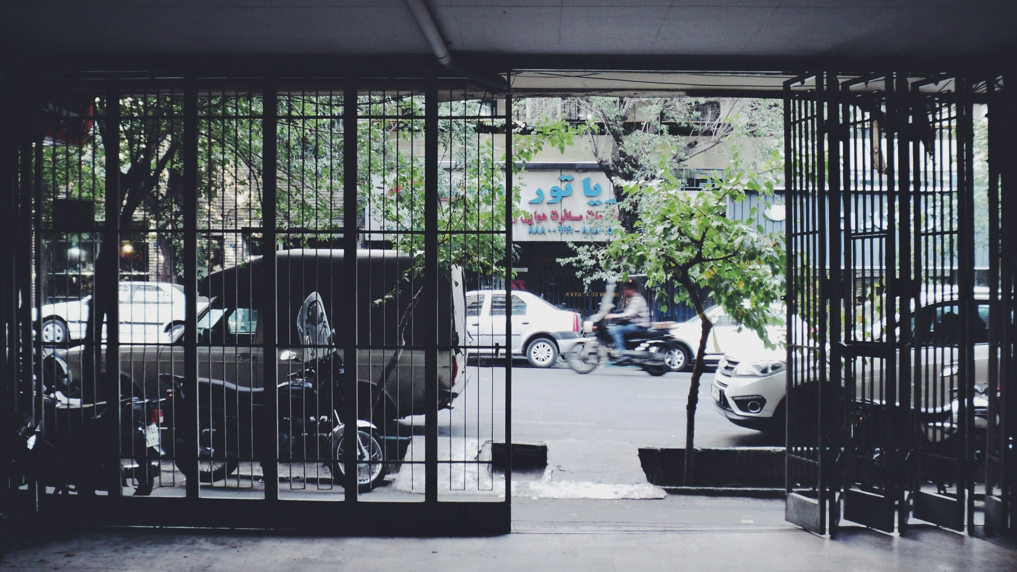 A window onto the world's stage. | A view through an open gate.