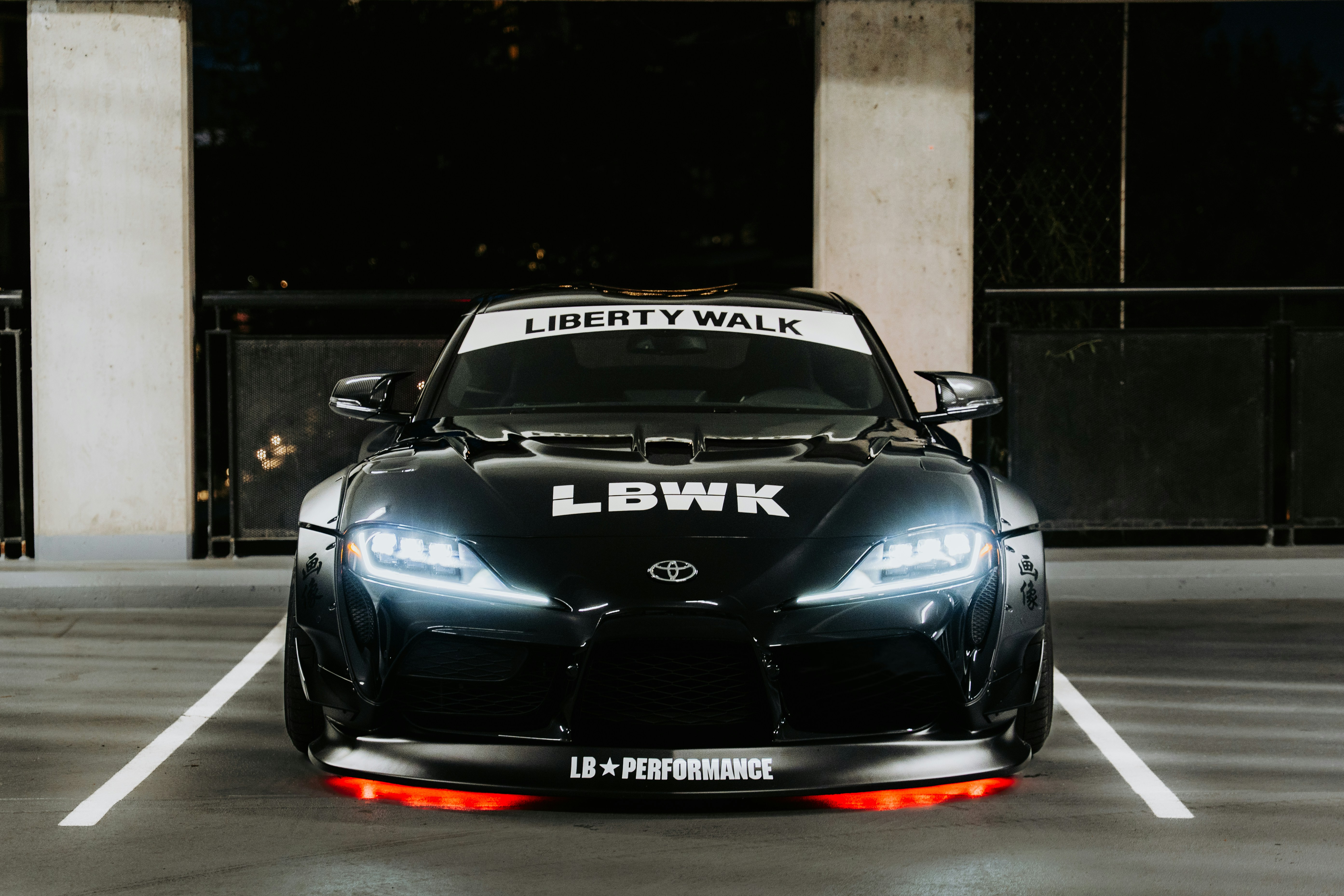 A black modified car is parked in the garage. photo – Free Car Image on ...