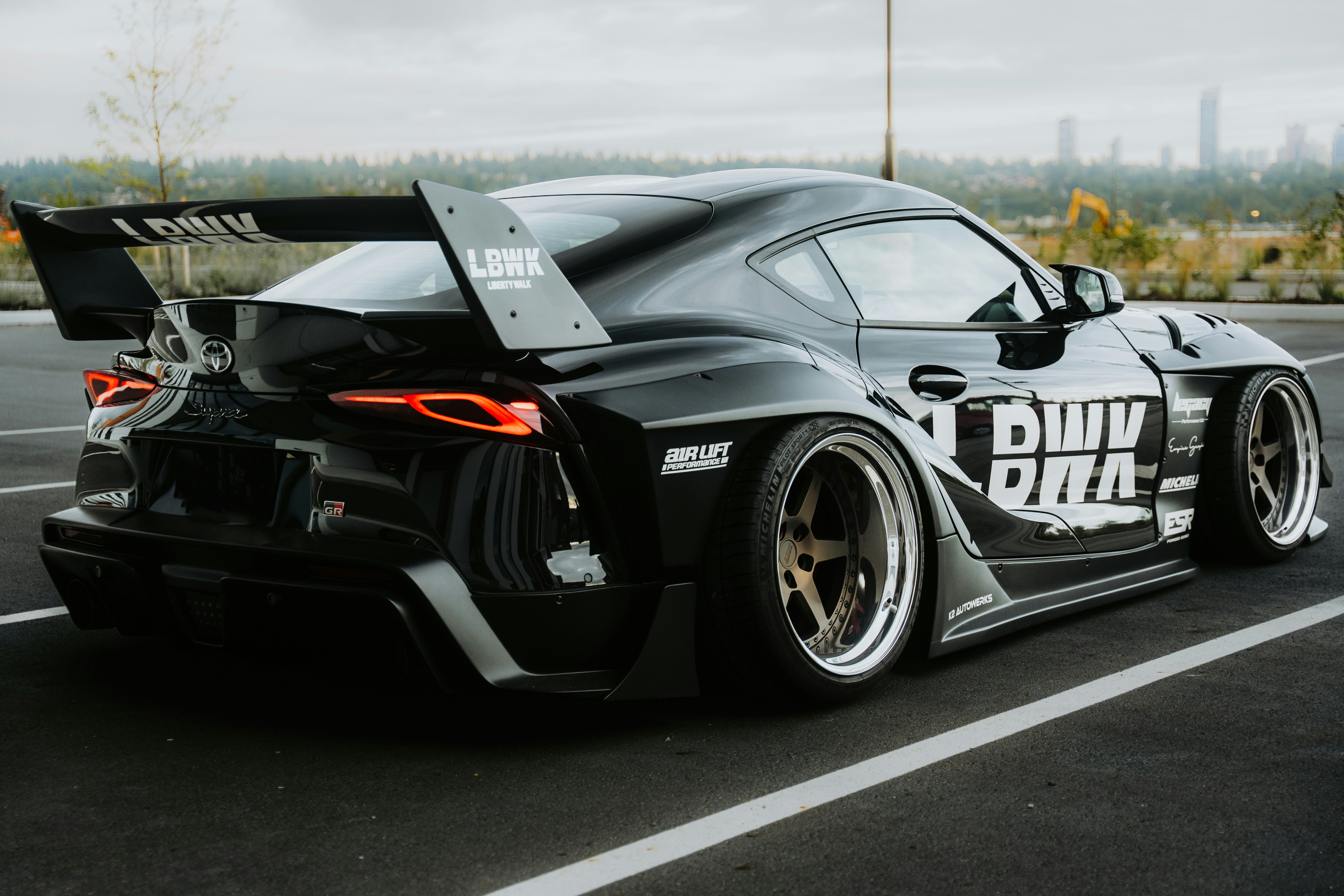 A black modified toyota supra with a large spoiler. photo – Free Car ...