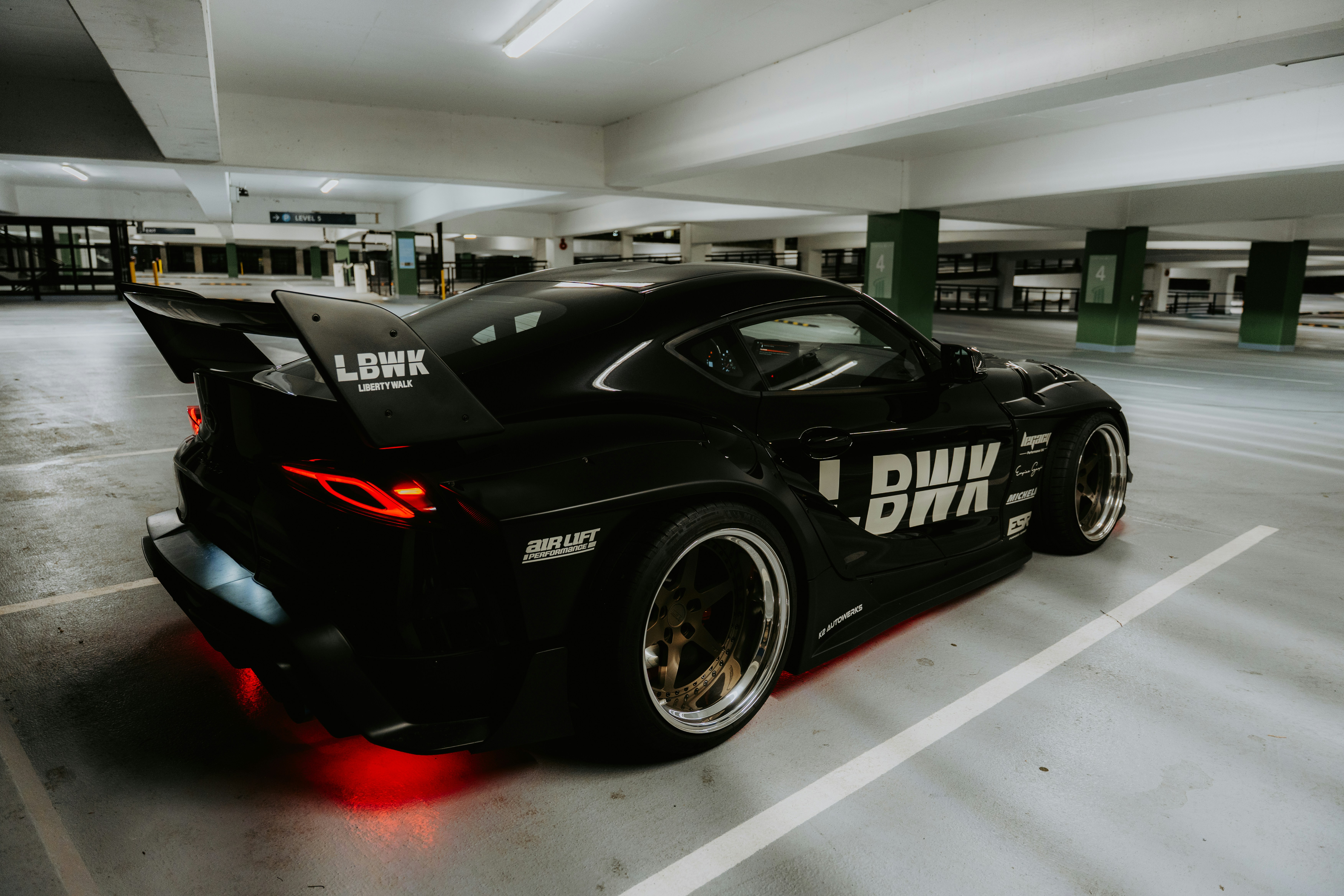 A black toyota supra parked in a garage.