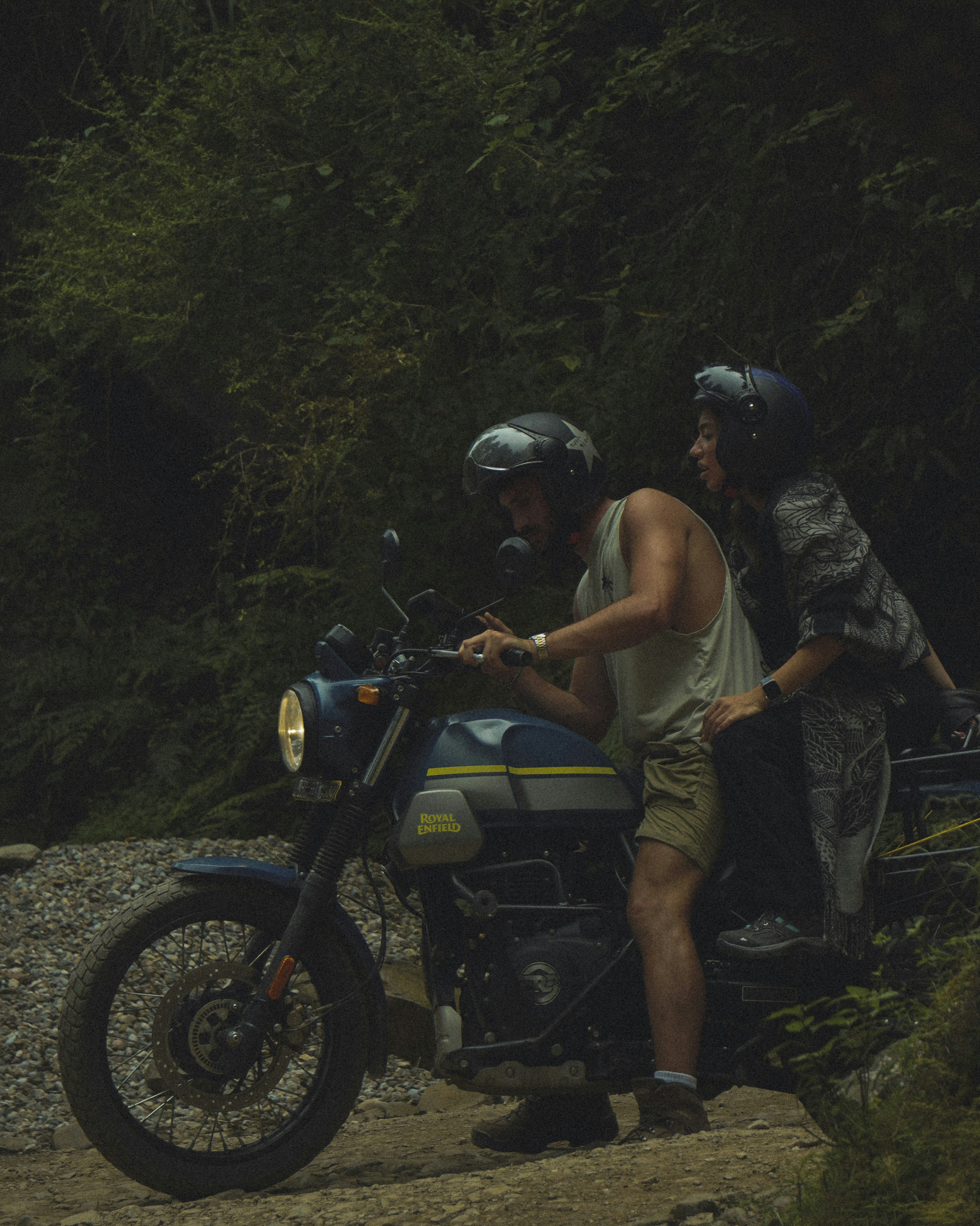 Couples riding bike in the middle of the wilderness | A couple rides a motorcycle on a trail.