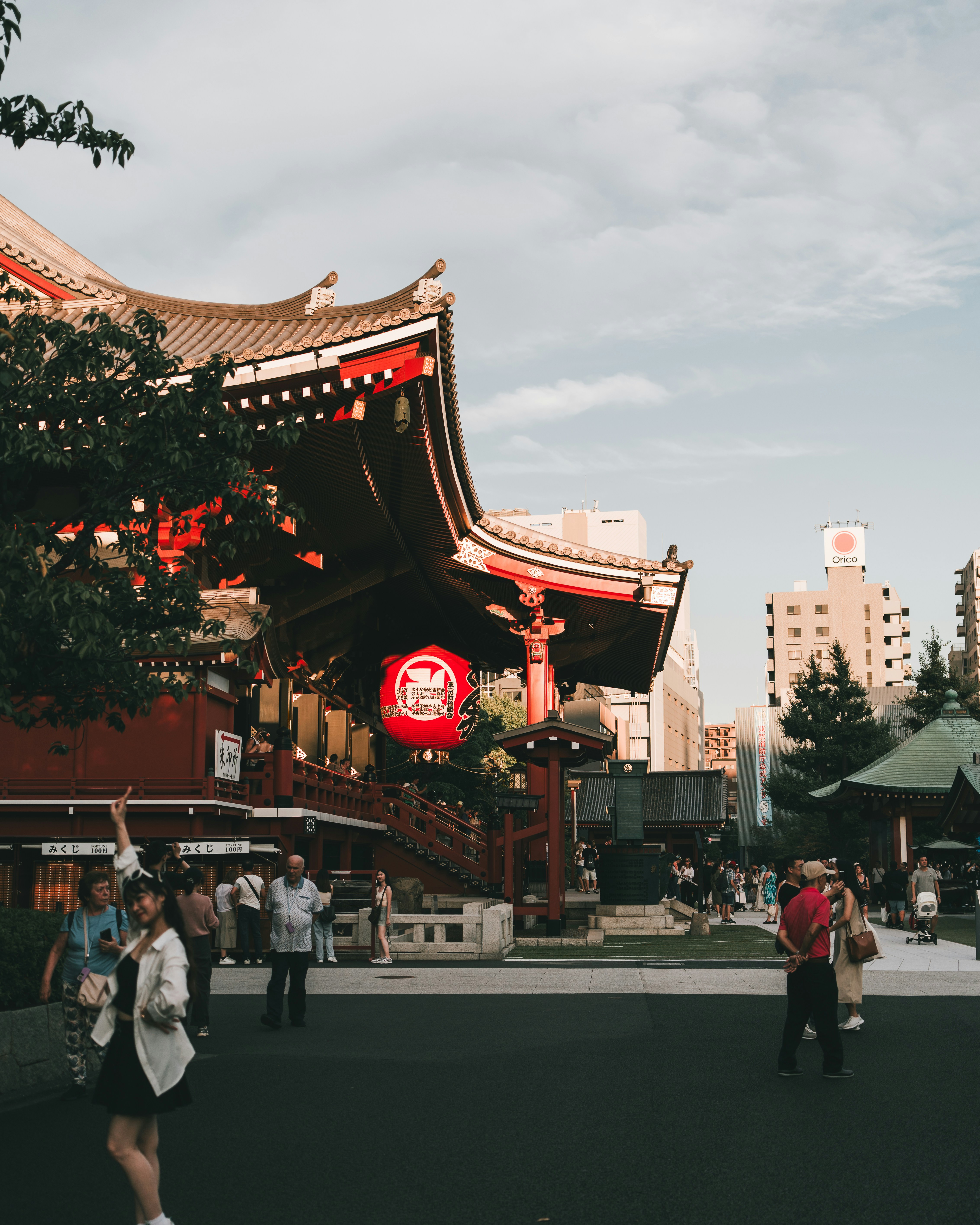 Japanese temple with people bustling around.