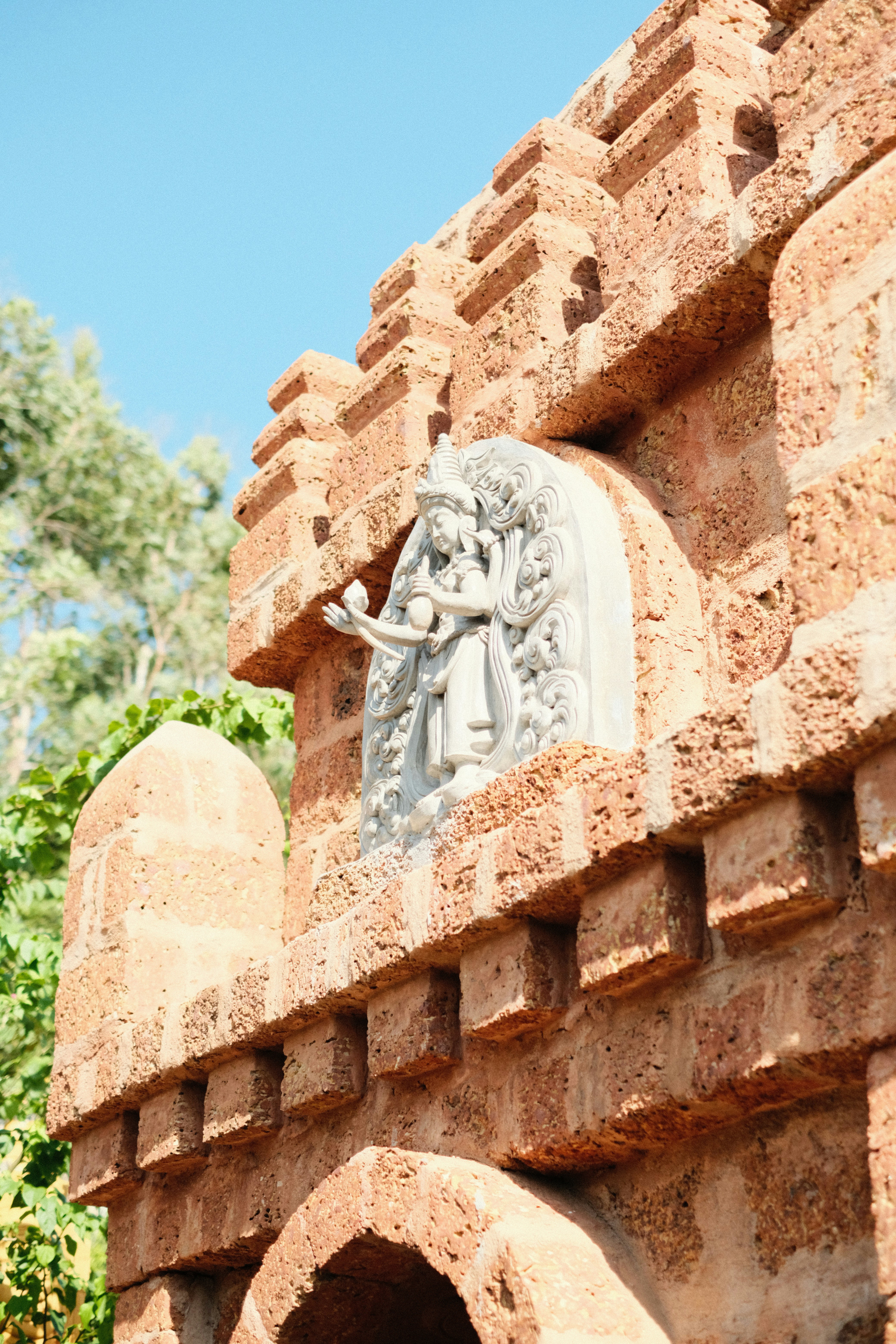 Statue on top of an ancient stone structure.