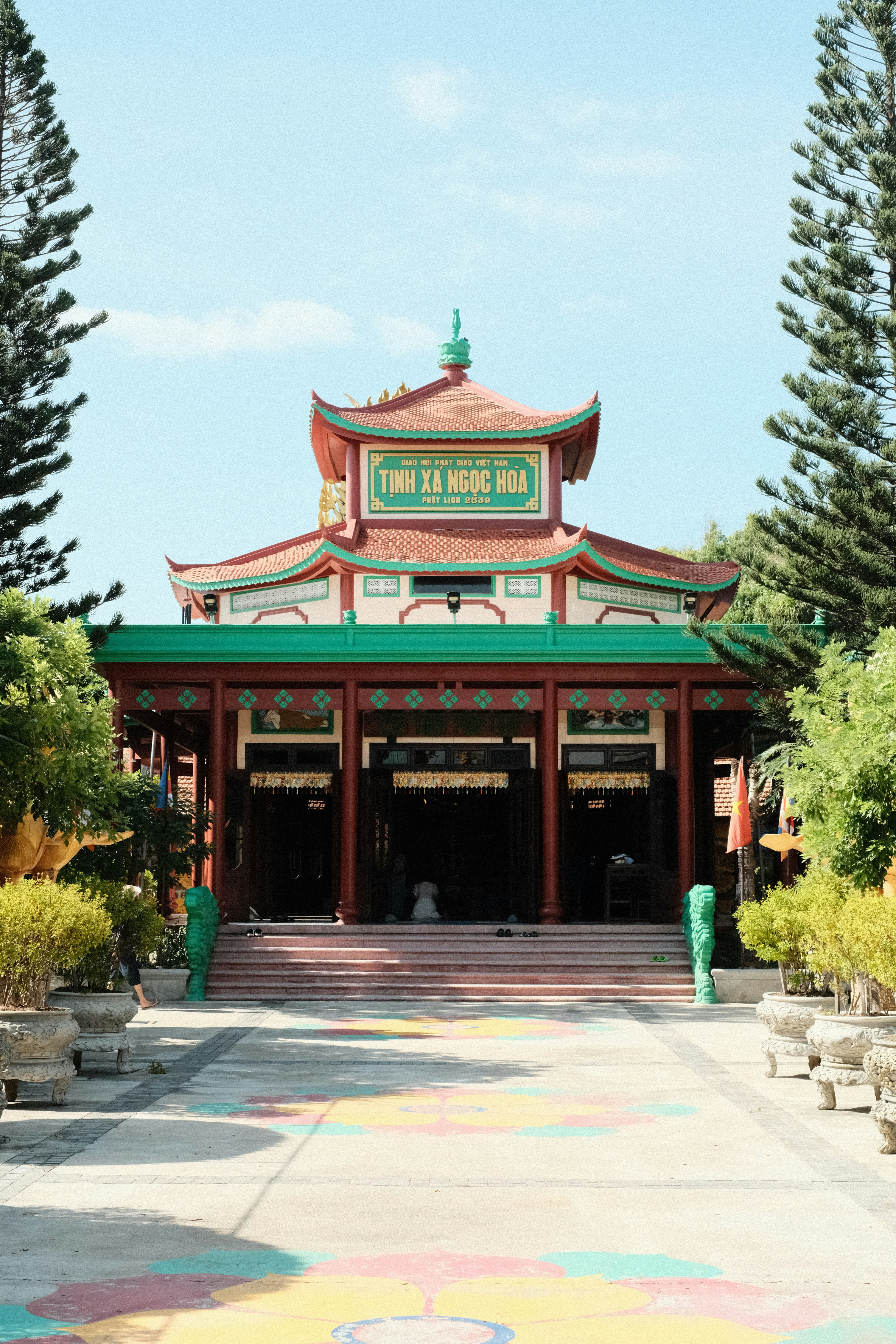 A buddhist temple stands prominently with vibrant colors.