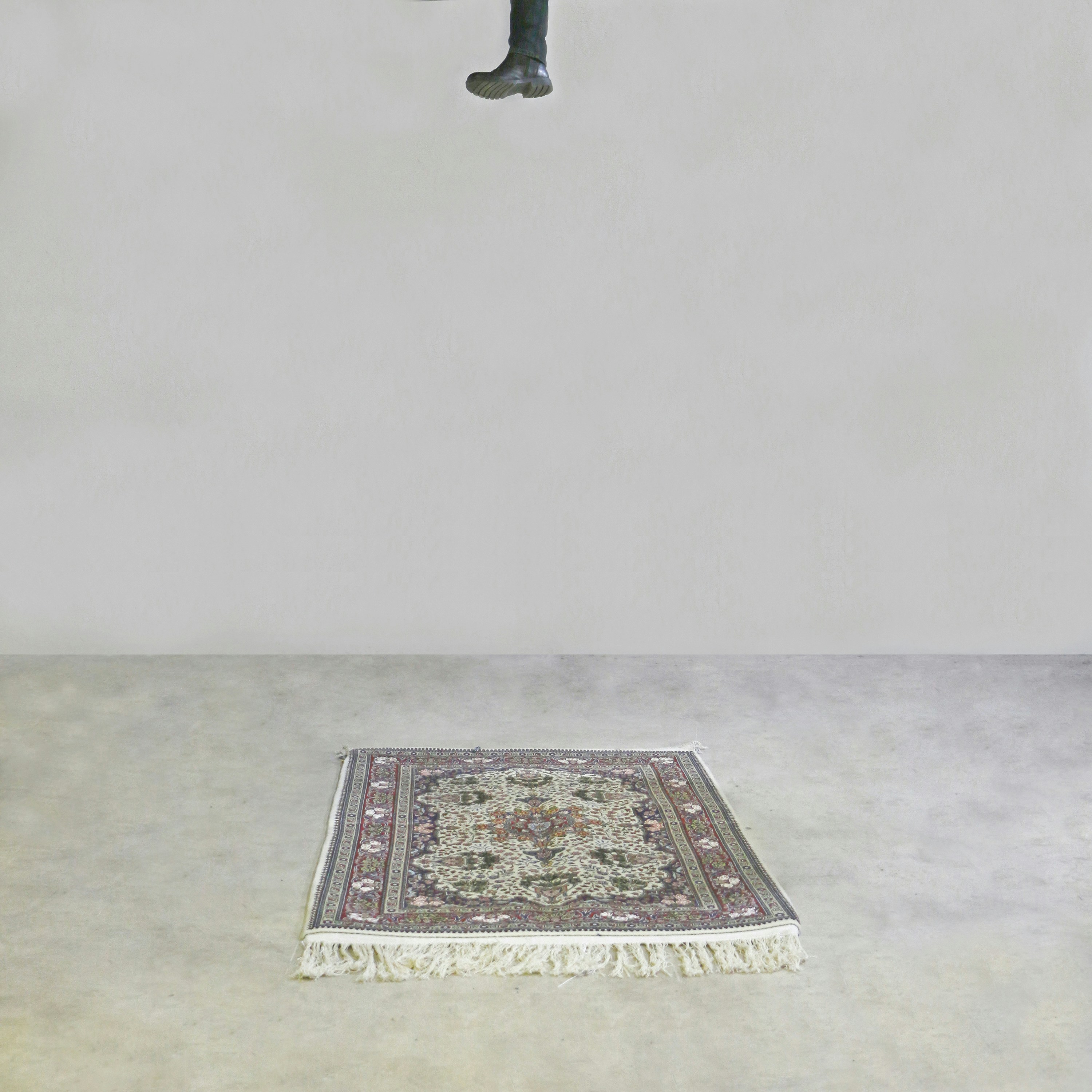A foot descends towards a rug.