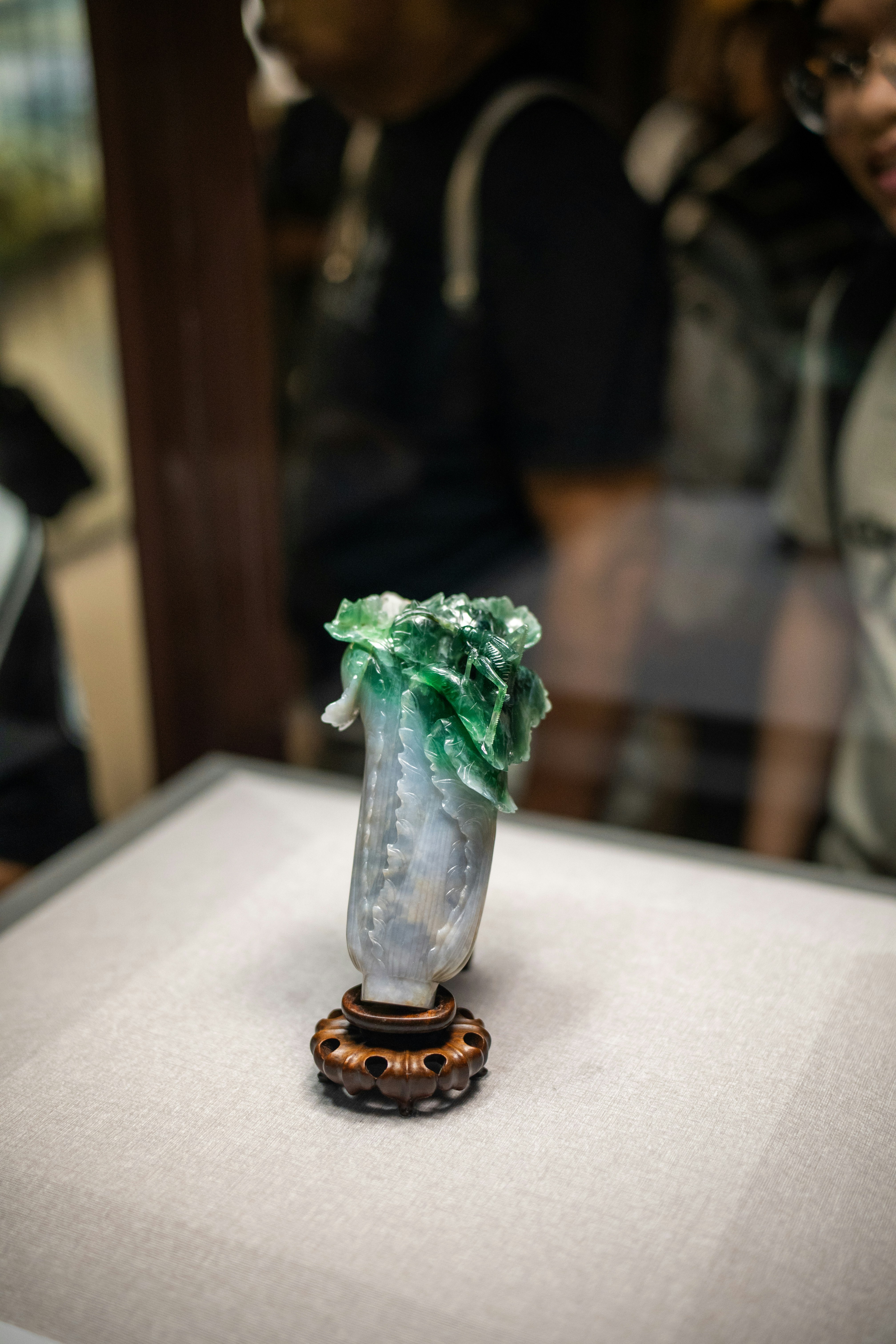 A jadeite cabbage is displayed in a glass case.
