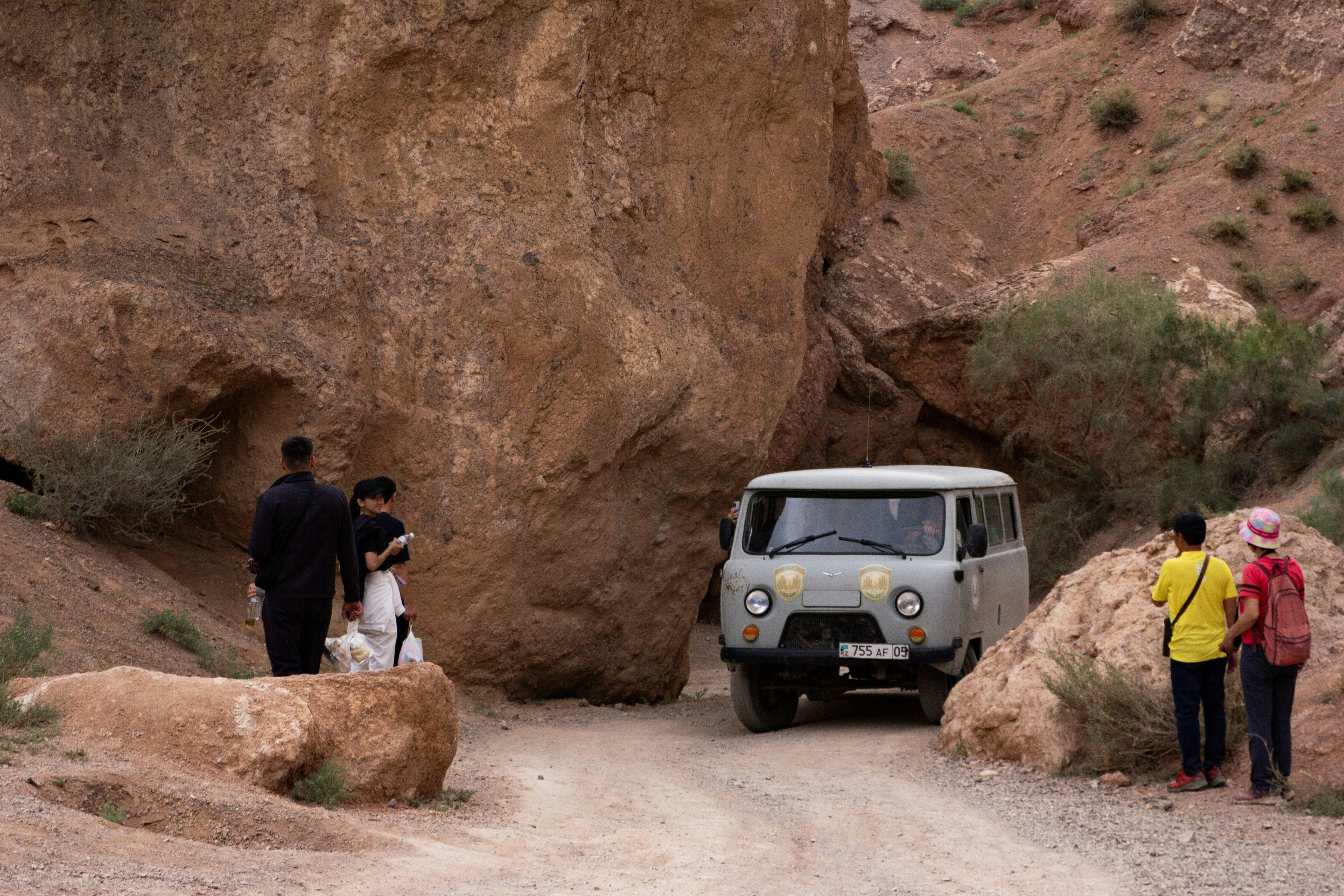 Dusty Gorge Rendezvous: A vintage van at the mouth of a canyon road