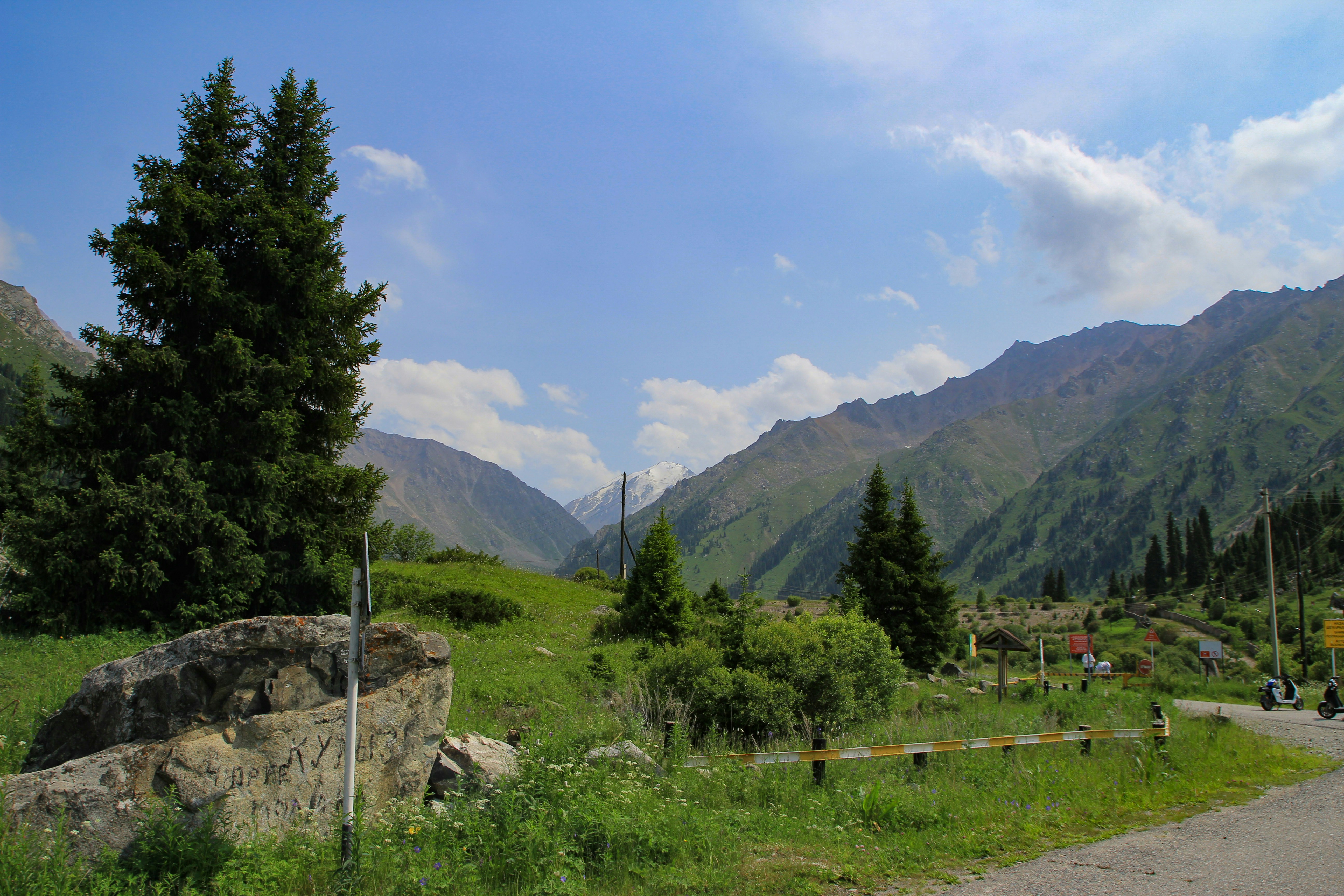 Mountains rise above a grassy valley.