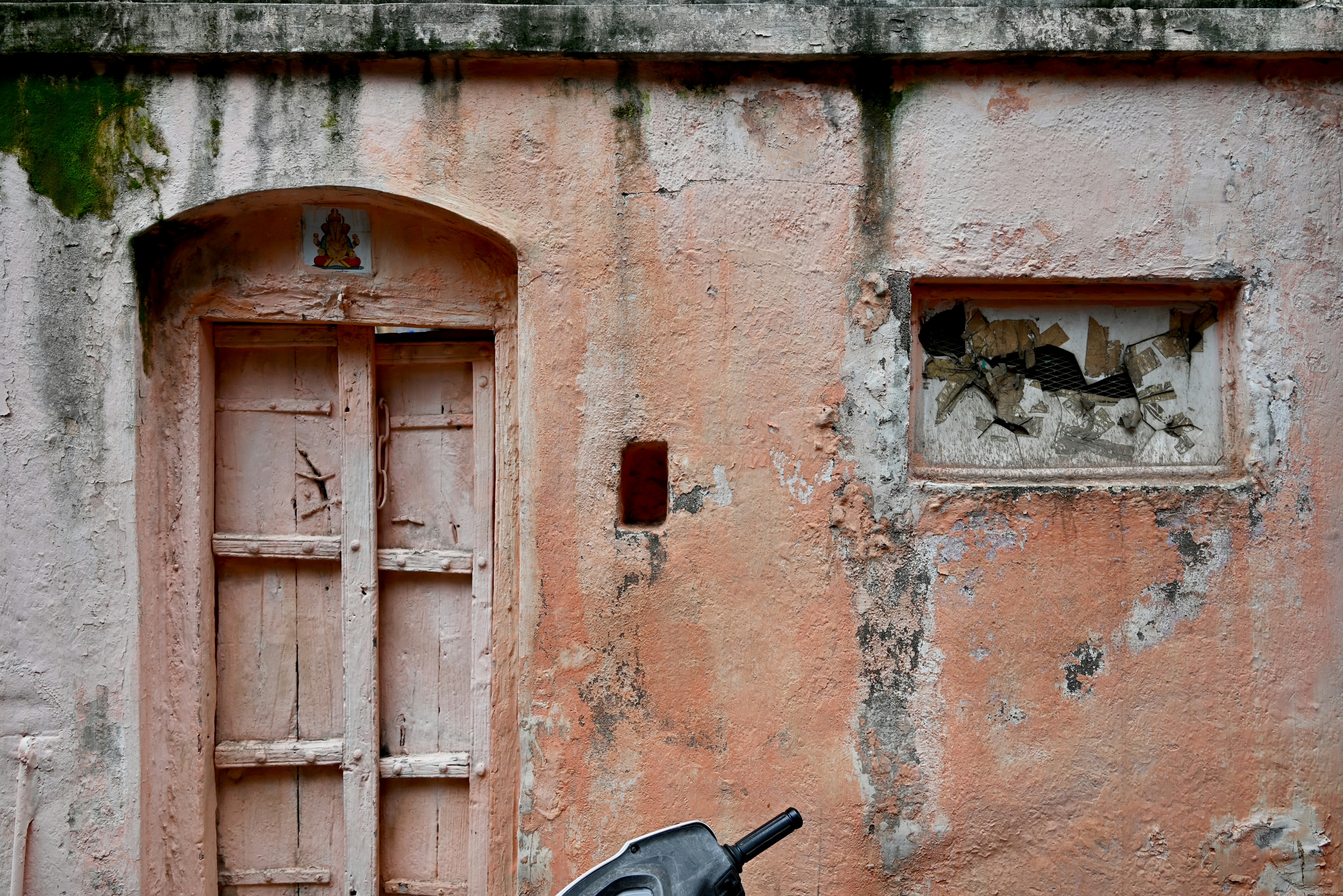 An old building with weathered door and window.