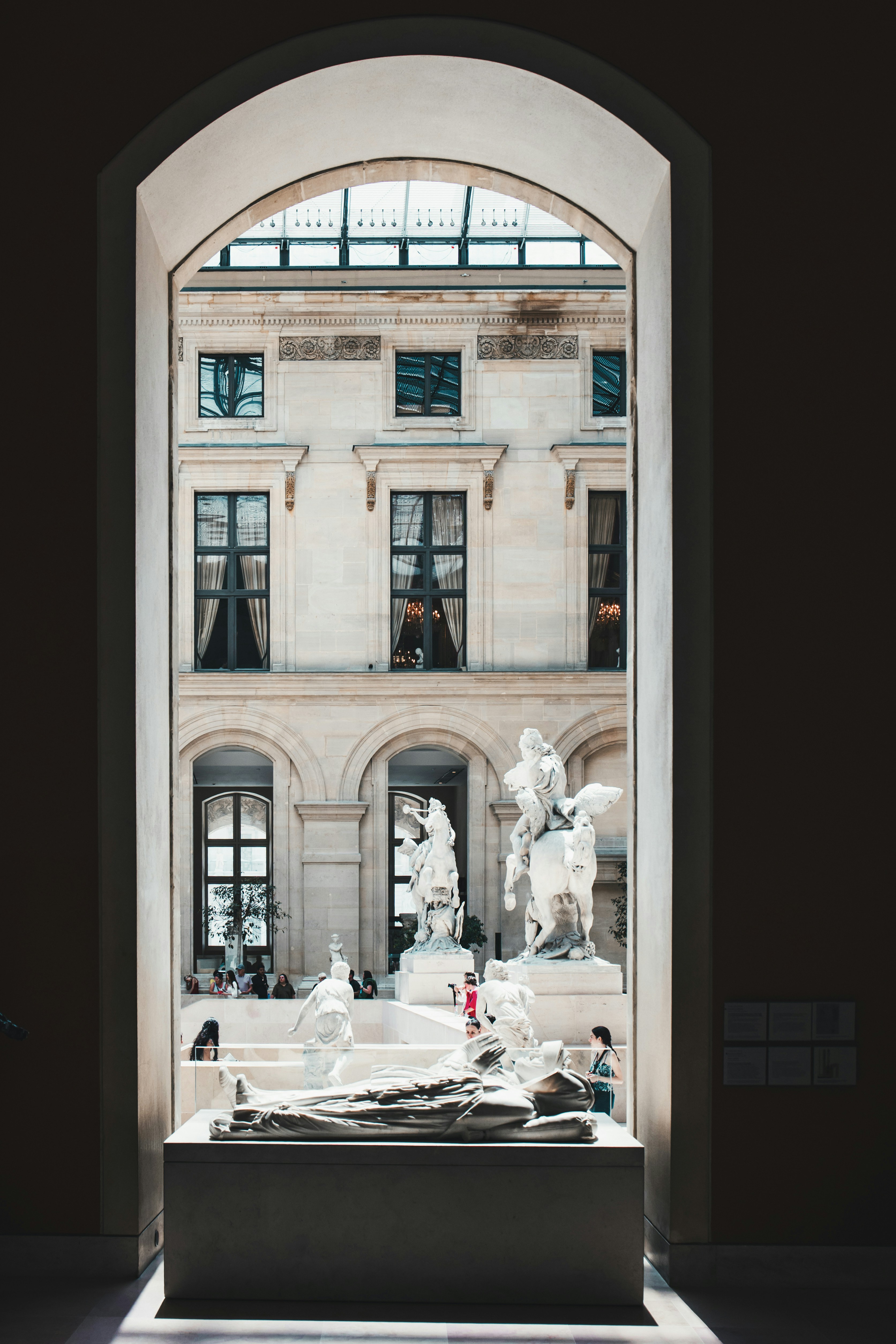 The image shows architecture with sculptures inside a museum. photo ...