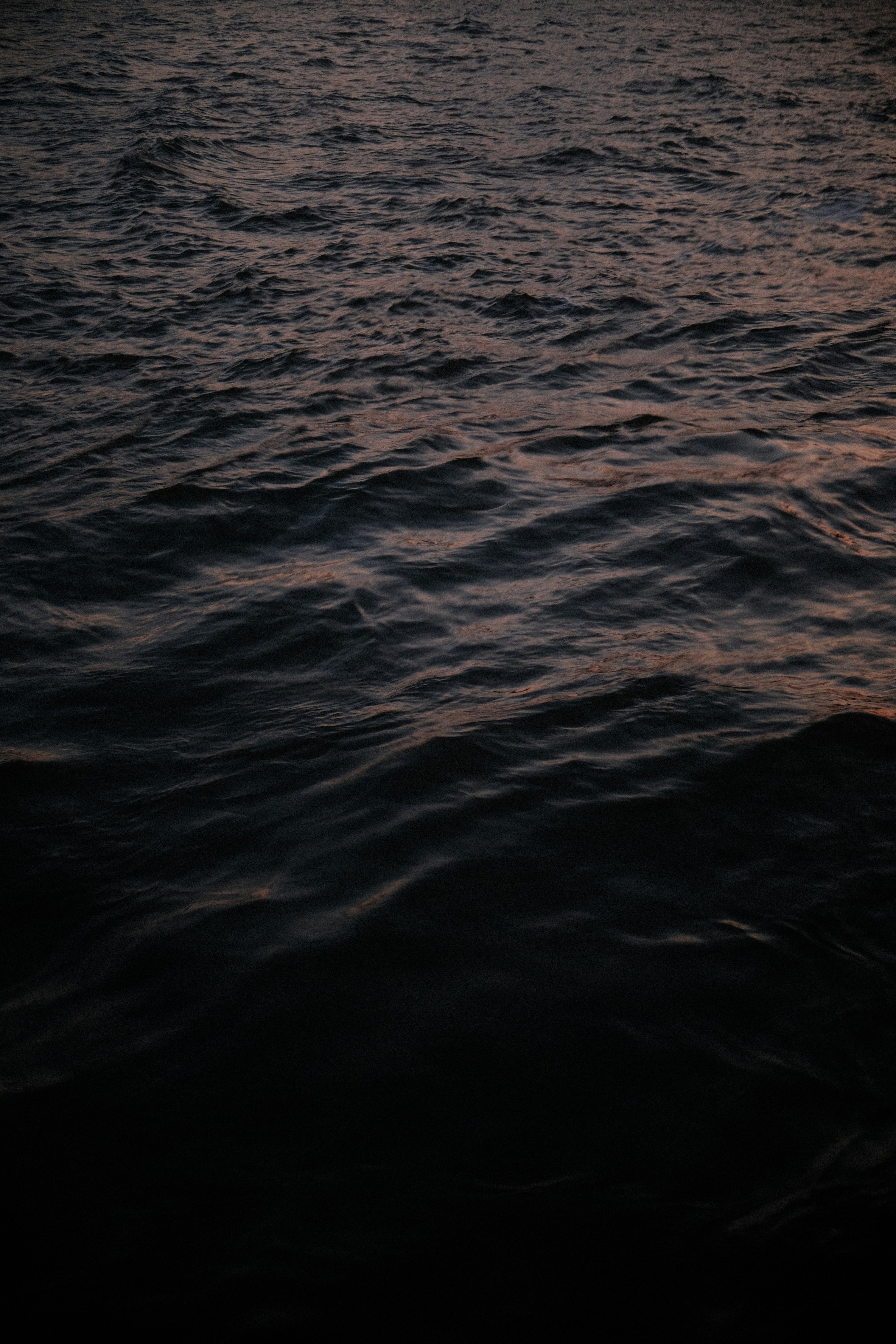Dark ocean waves at sunset.