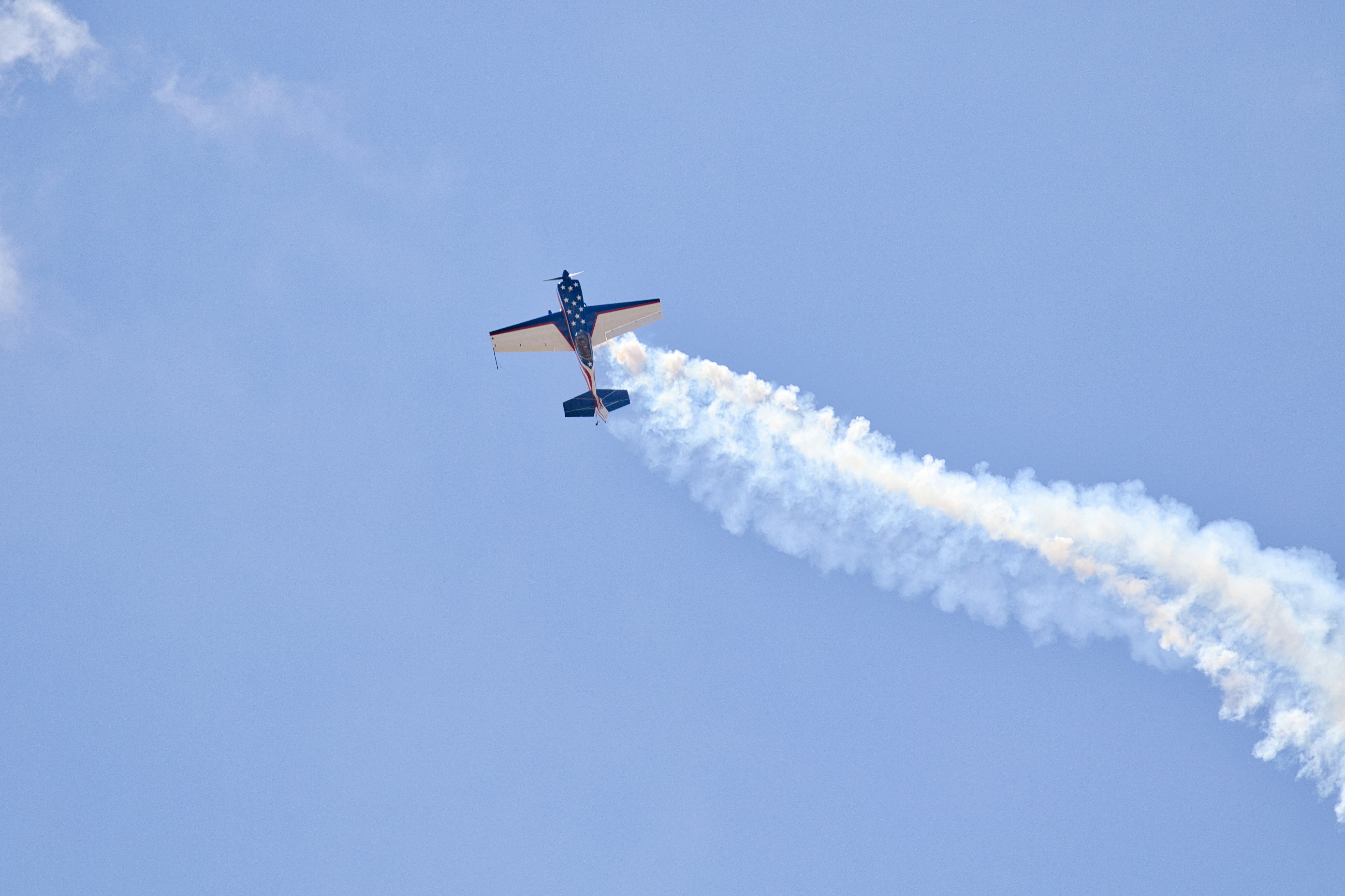 Craig Staudacher S300 | An airplane performs an aerial maneuver, creating smoke.