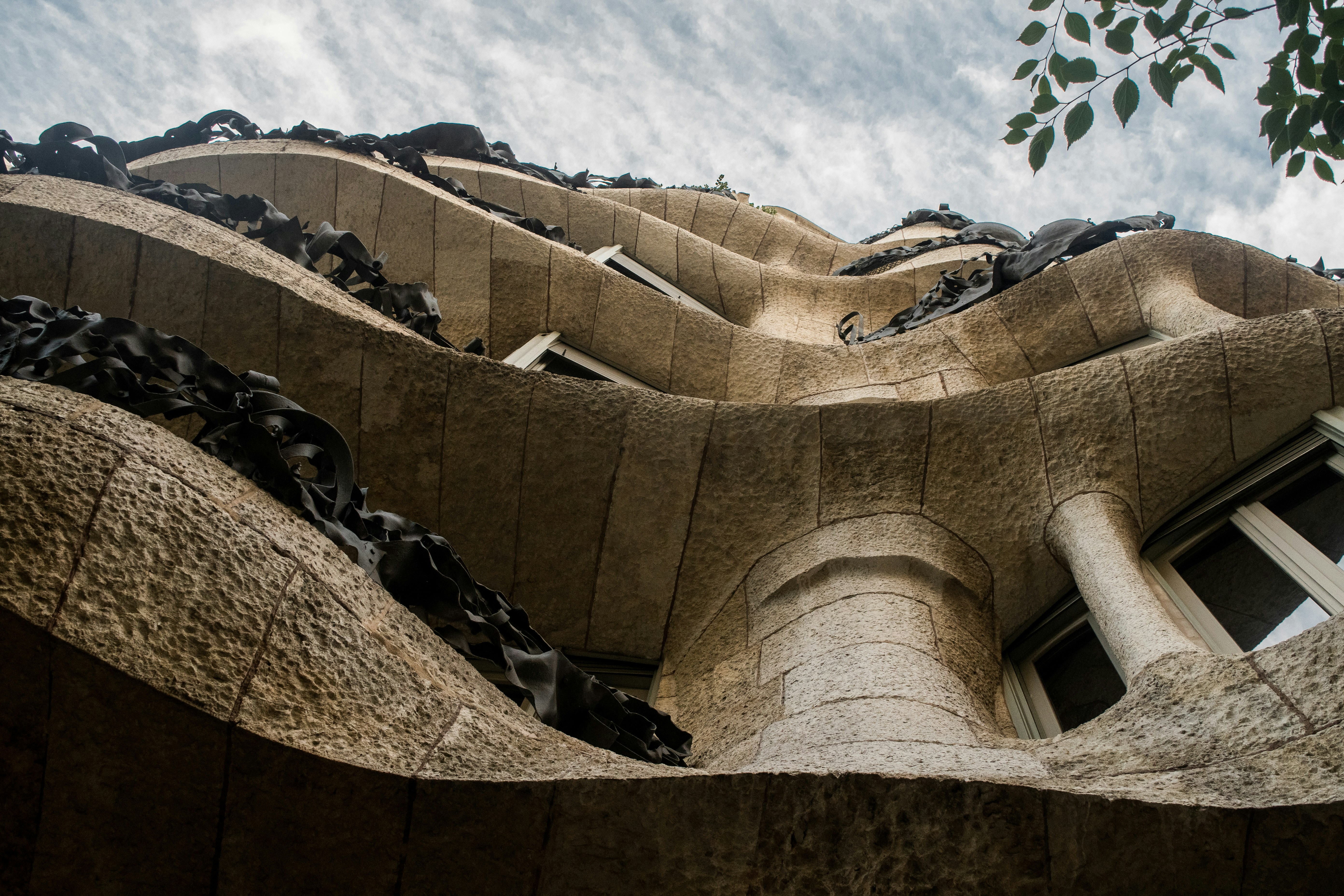 A unique, wavy building is seen from below. photo – Free City Image on ...