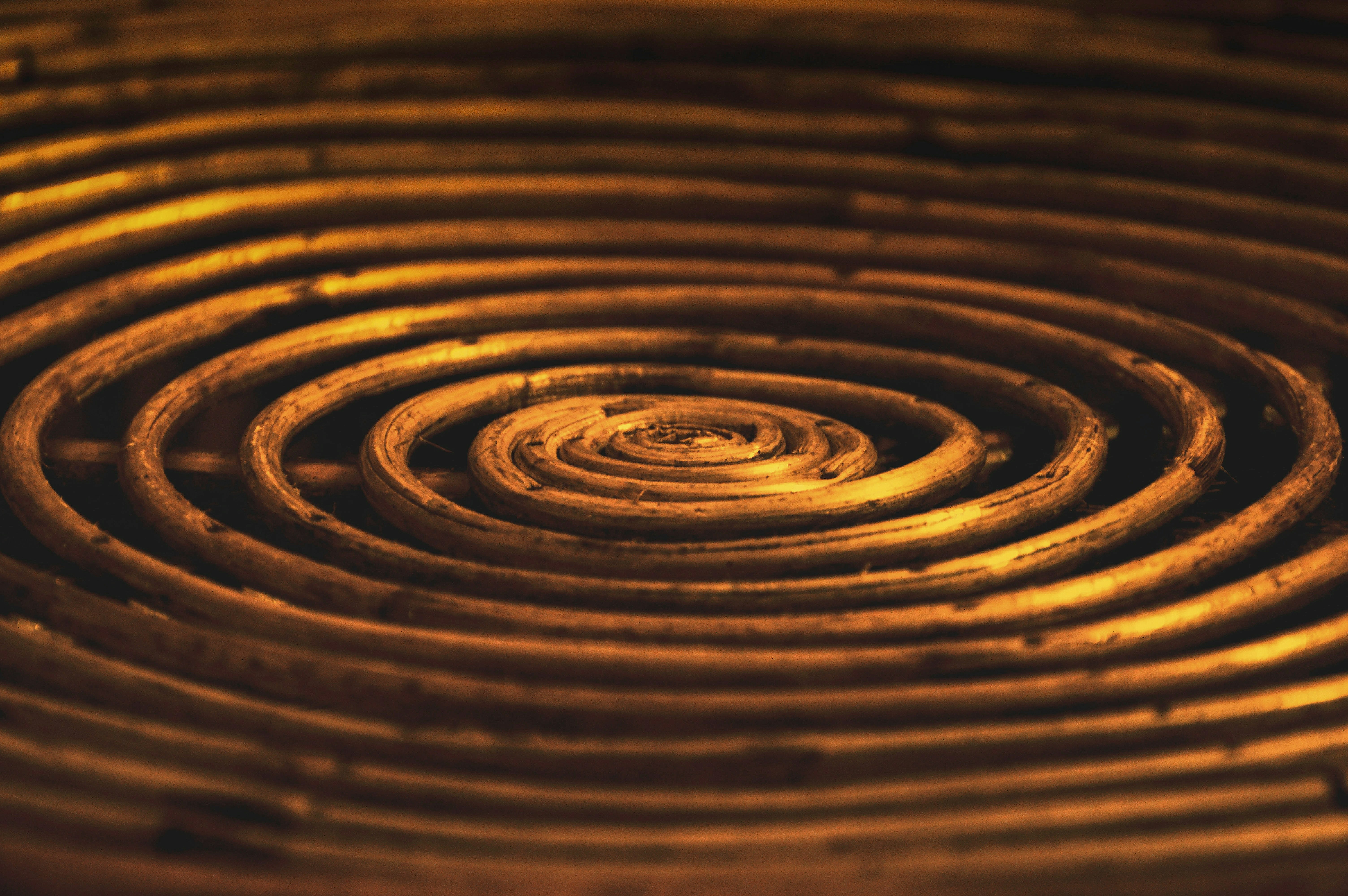 Intricate spiral patterns illuminated by warm light, showcasing the texture and depth of the material.