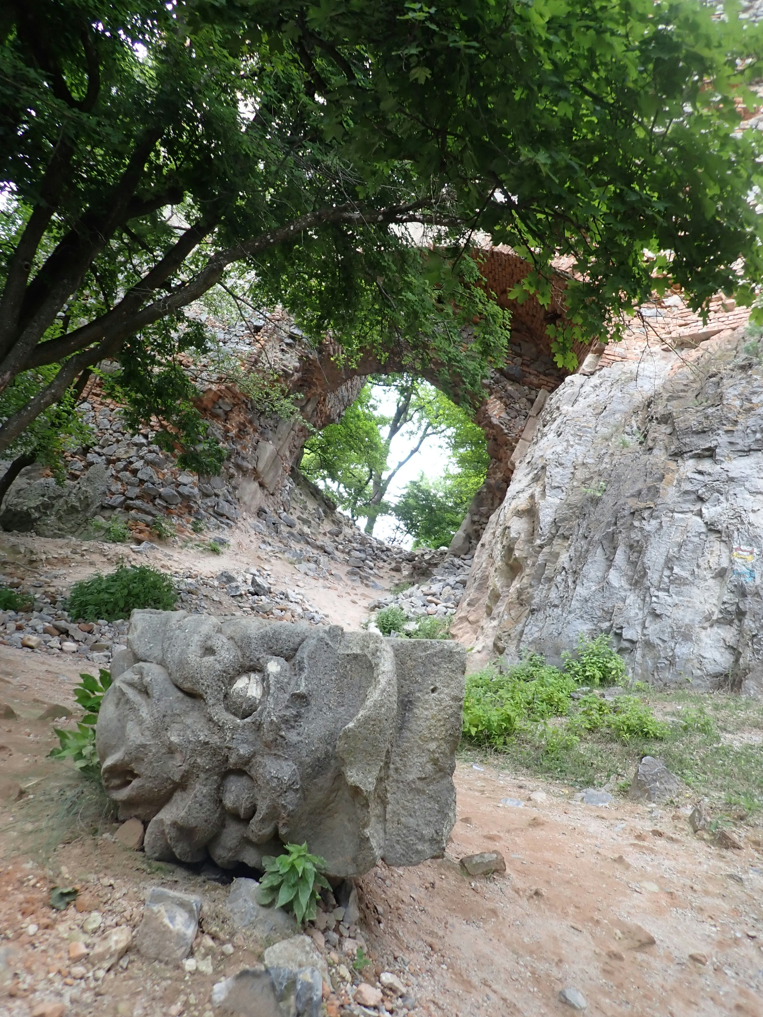 Ruins of Pajštún | Ancient ruins and natural rock arch in the landscape.