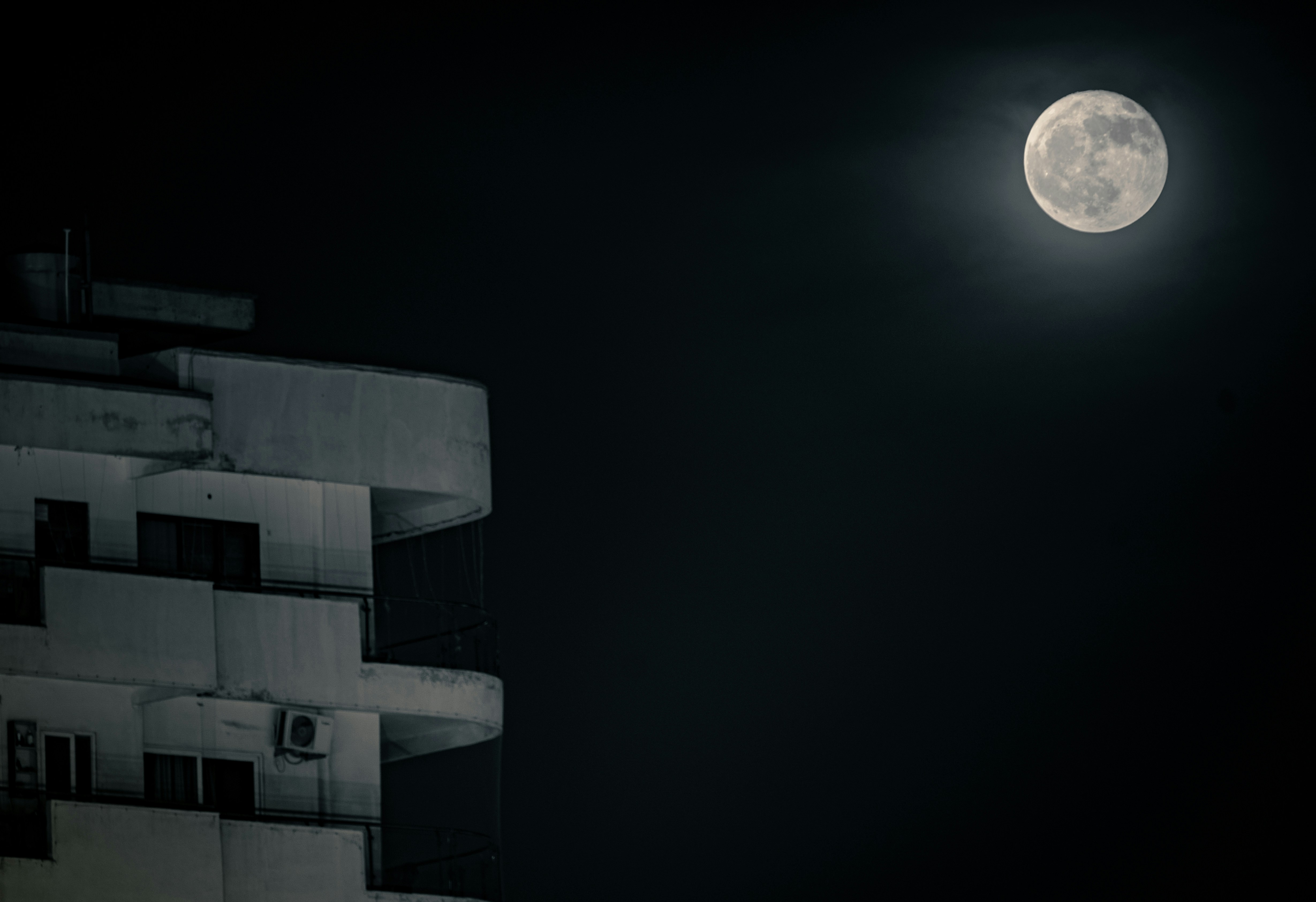 Urban Silhouette Beneath the Lunar Glow