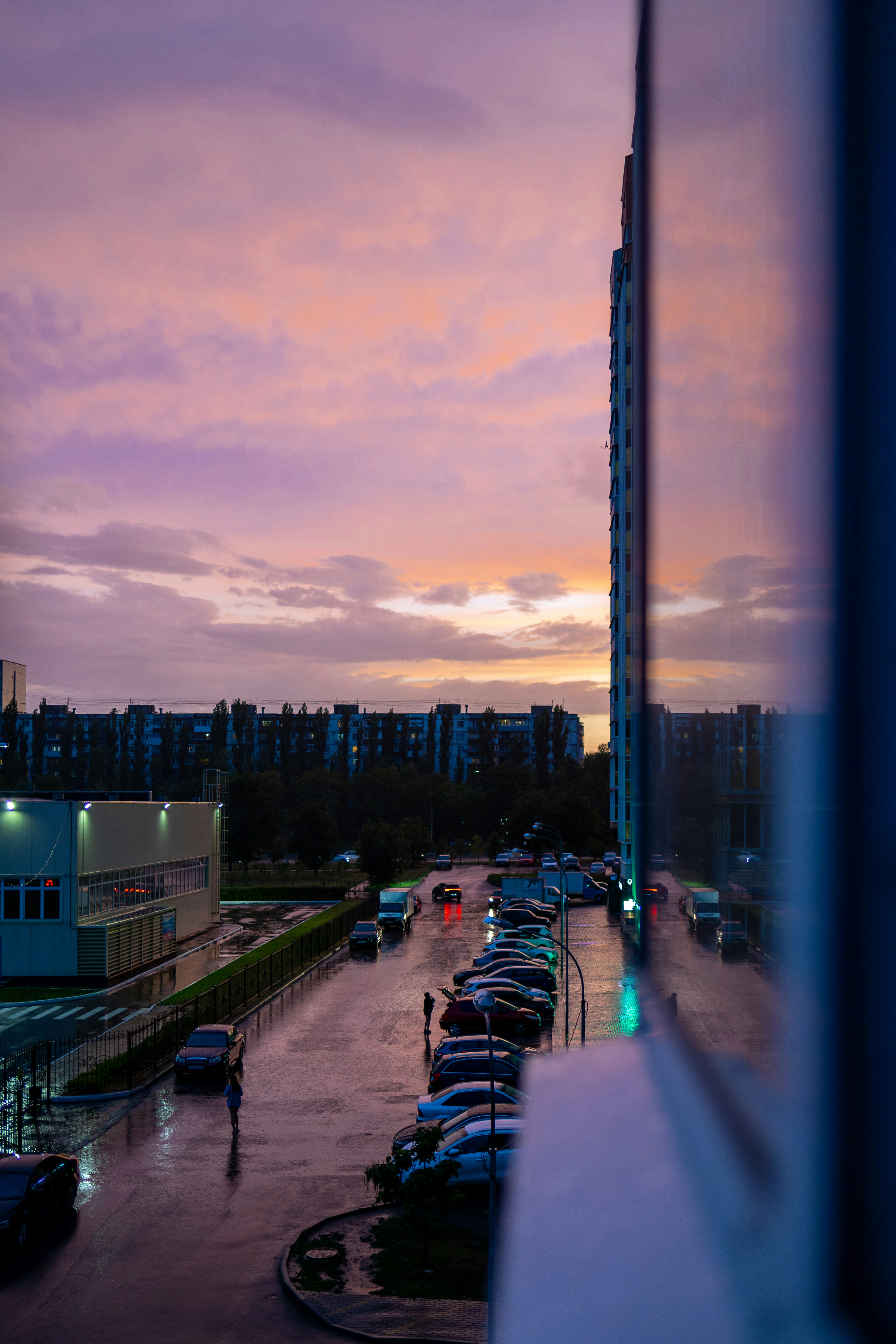A purple sunset glows over a cityscape.