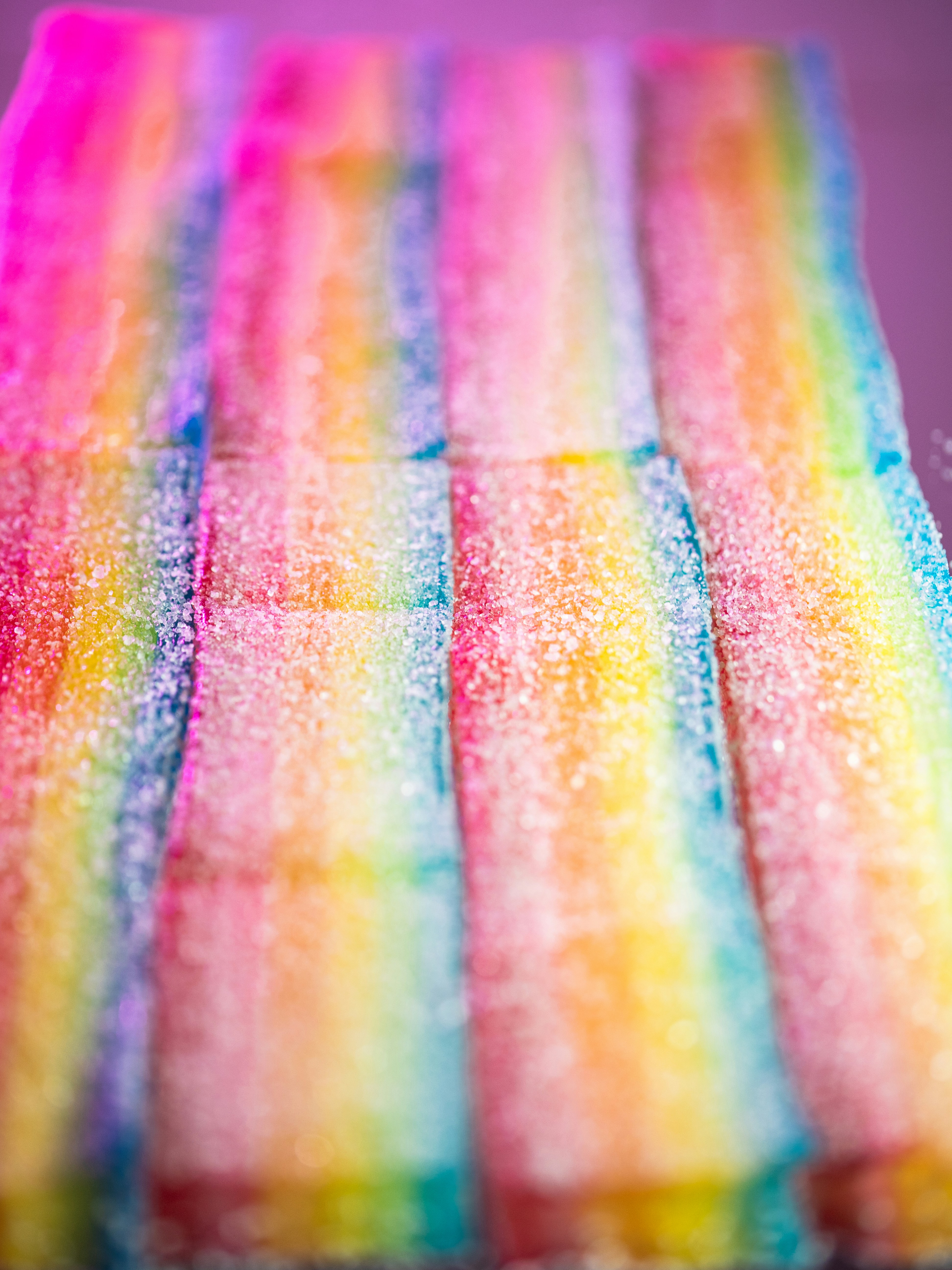 Rainbow candy strips sparkle in the light.