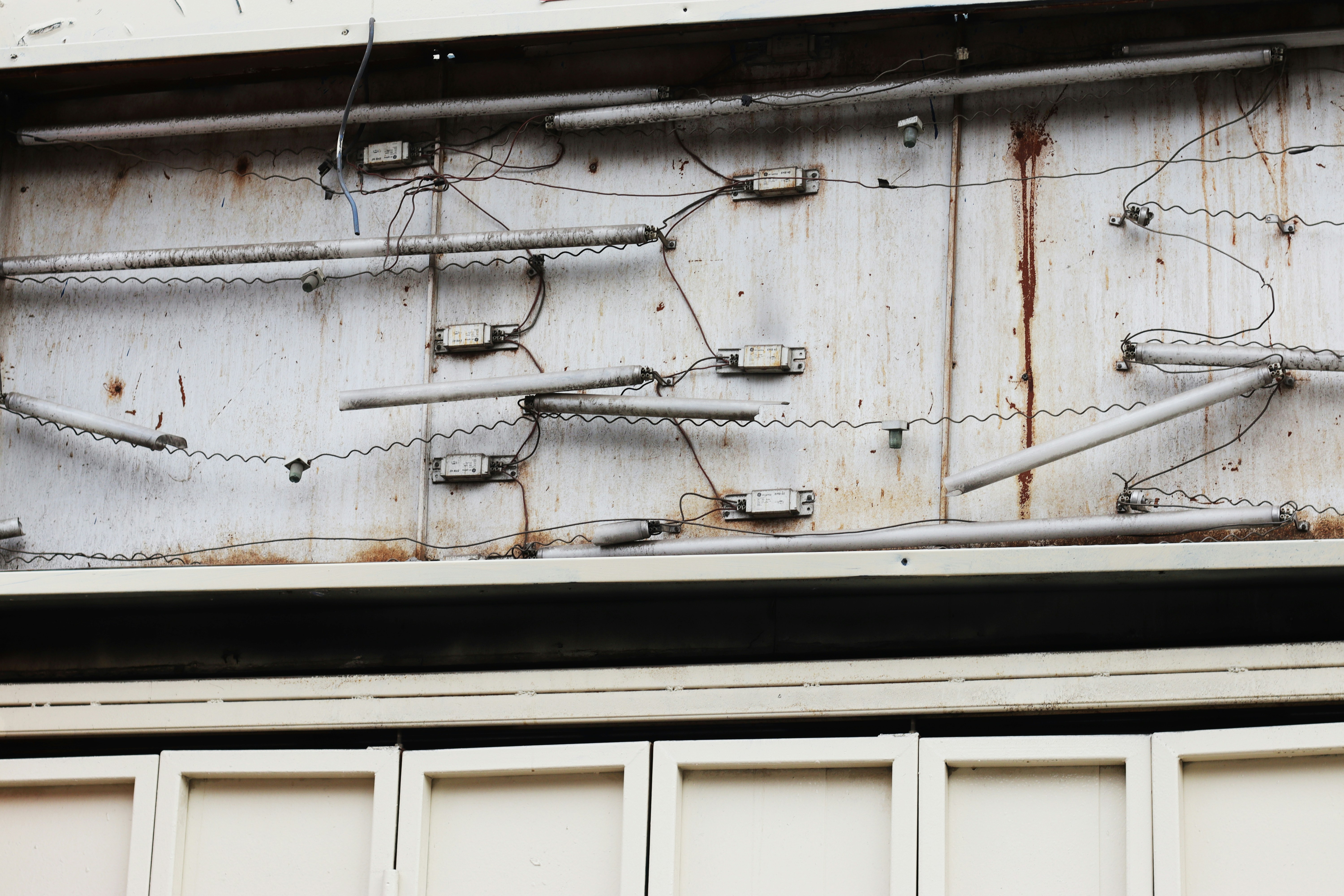 Old billboard with exposed wiring and lights.