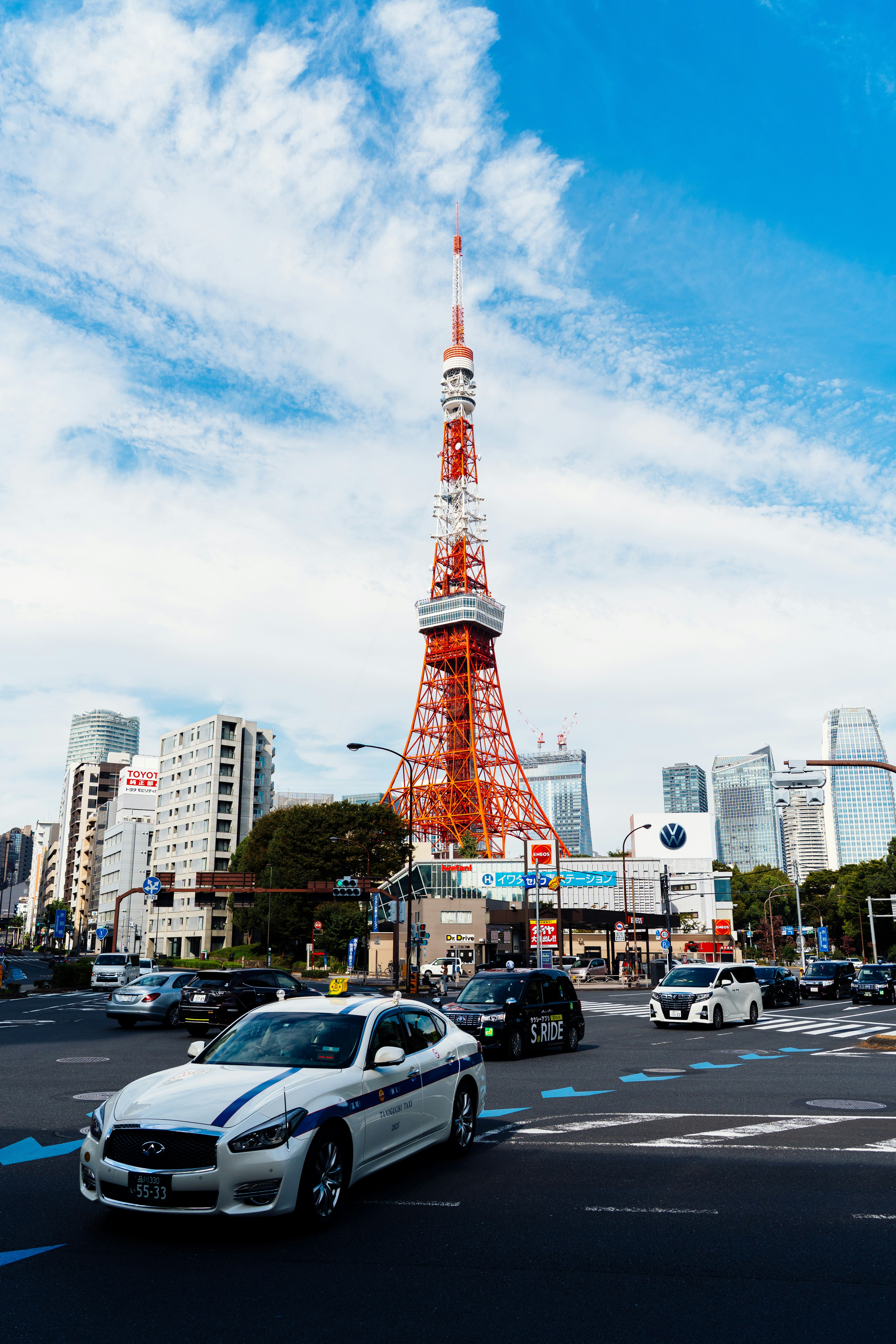Tokyo Tower Rising Over a Bustling City Intersection
