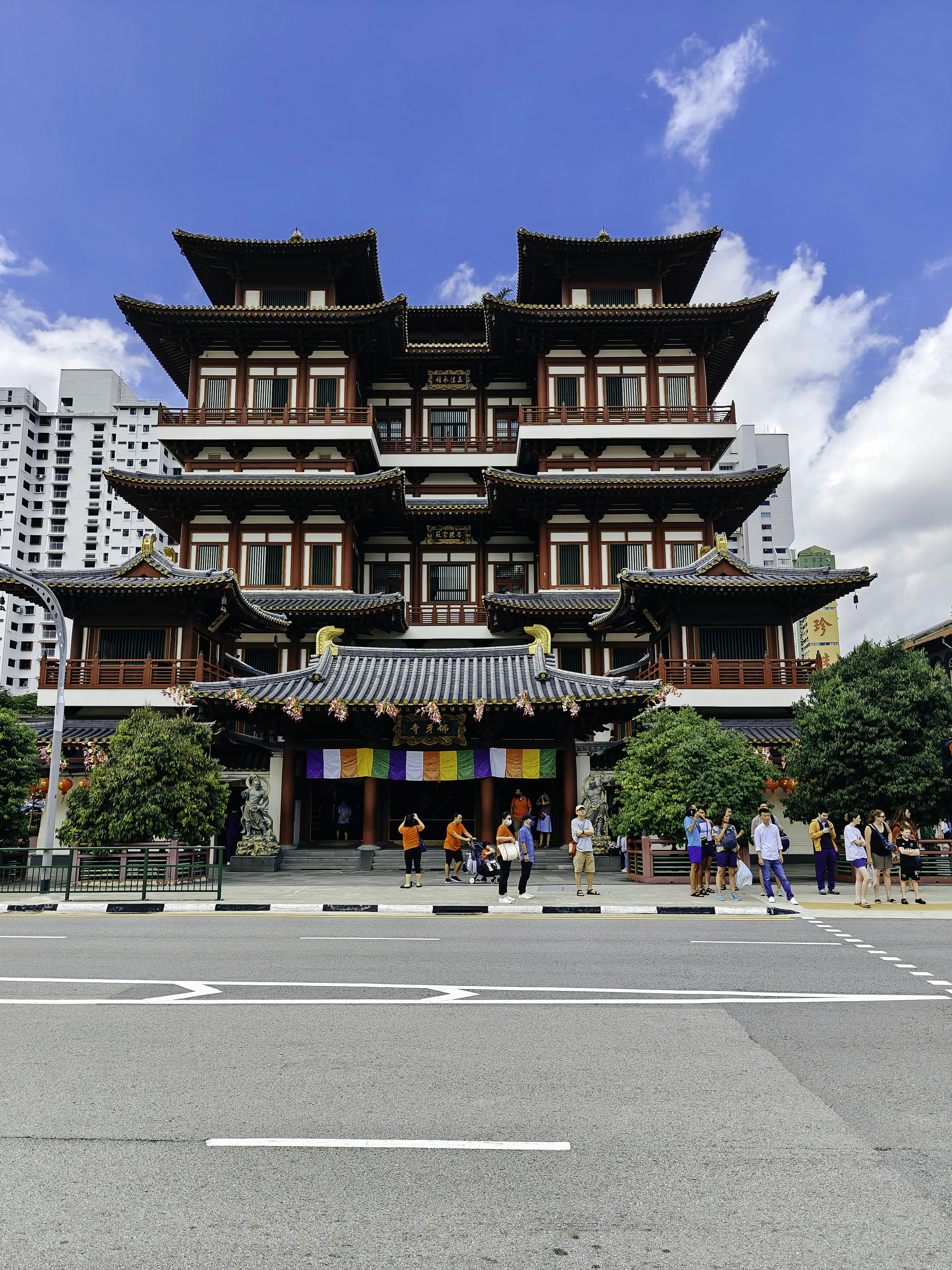 Buddha Tooth Relic Temple, Chinatown, Singapore | A traditional temple sits under a bright blue sky.