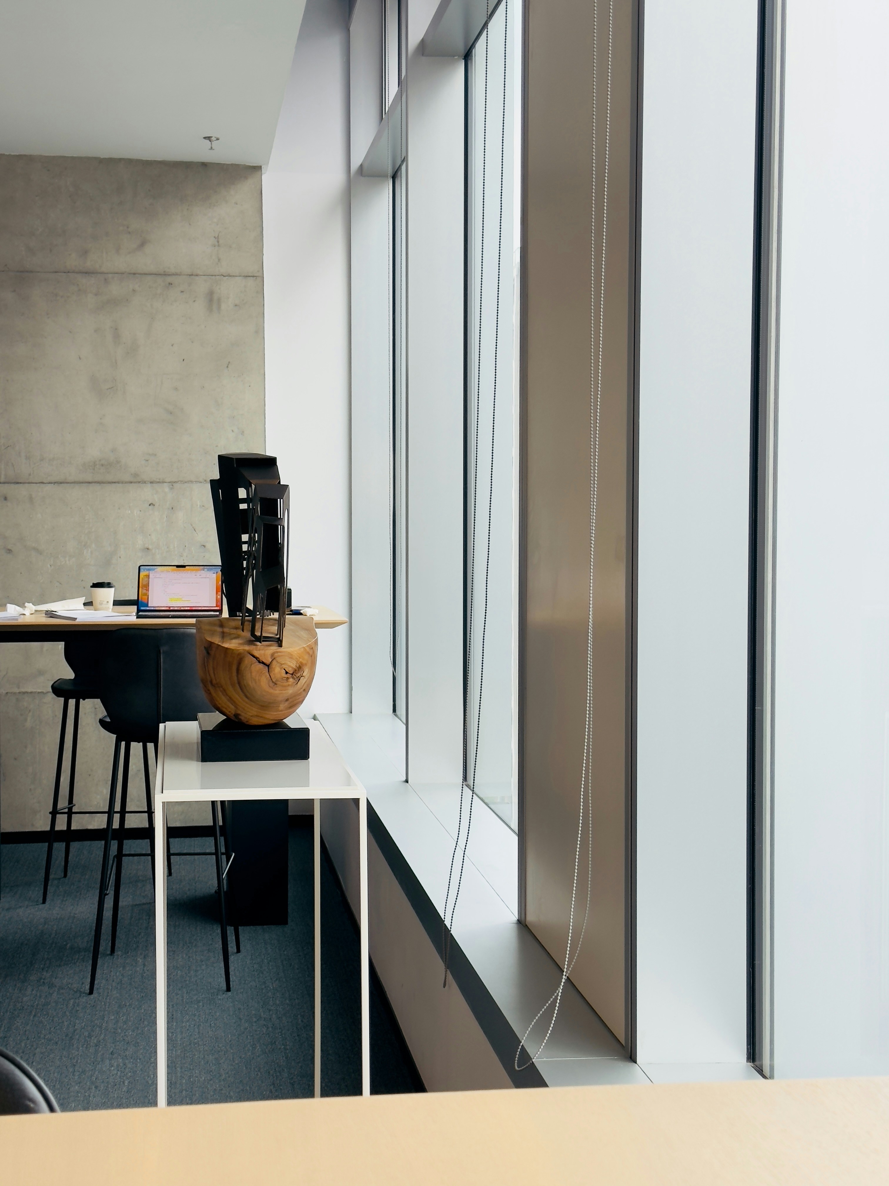 An office interior with art and a large window.