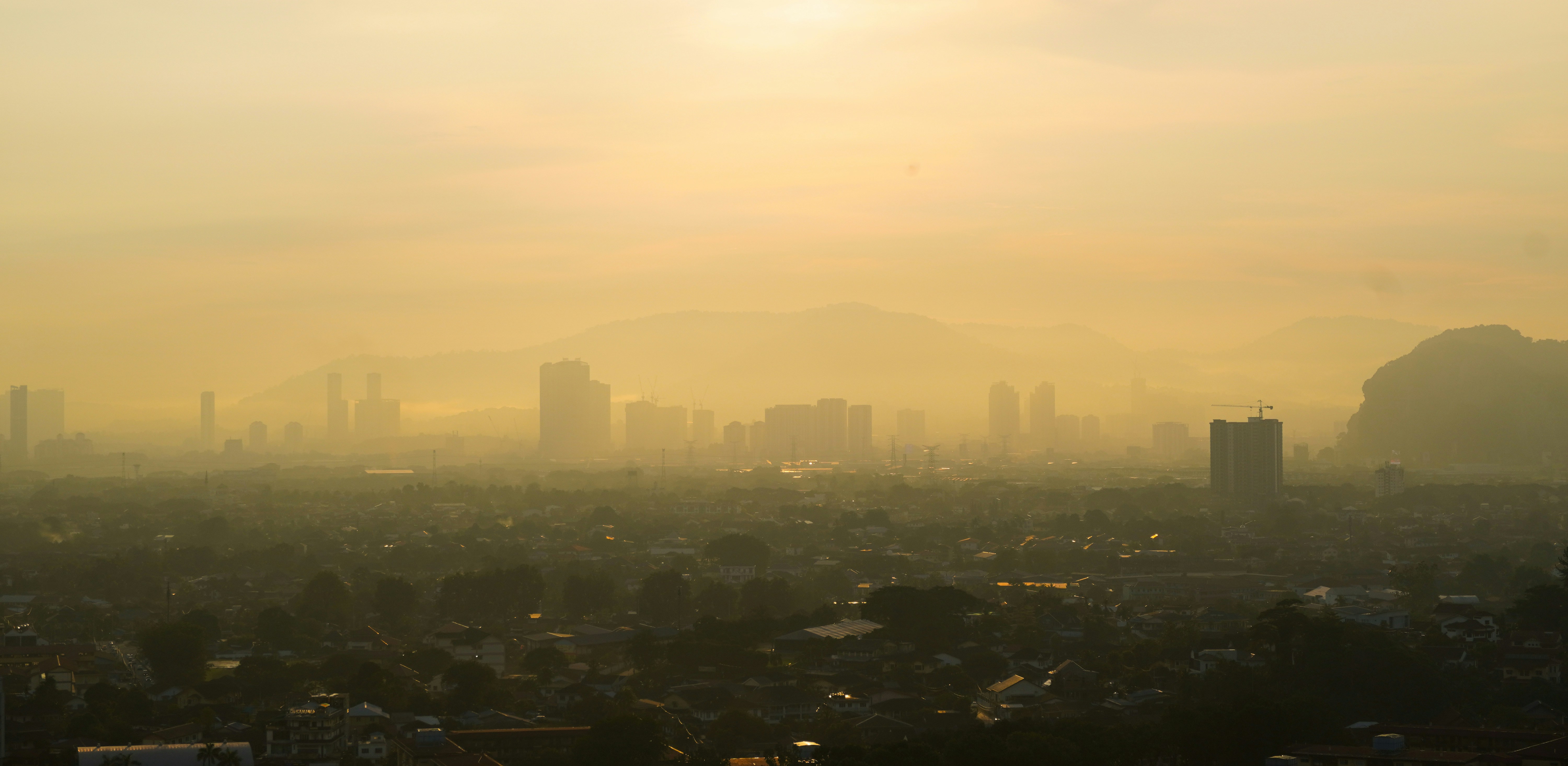 Ordinary Moment | City skyline shrouded in smog and morning mist.