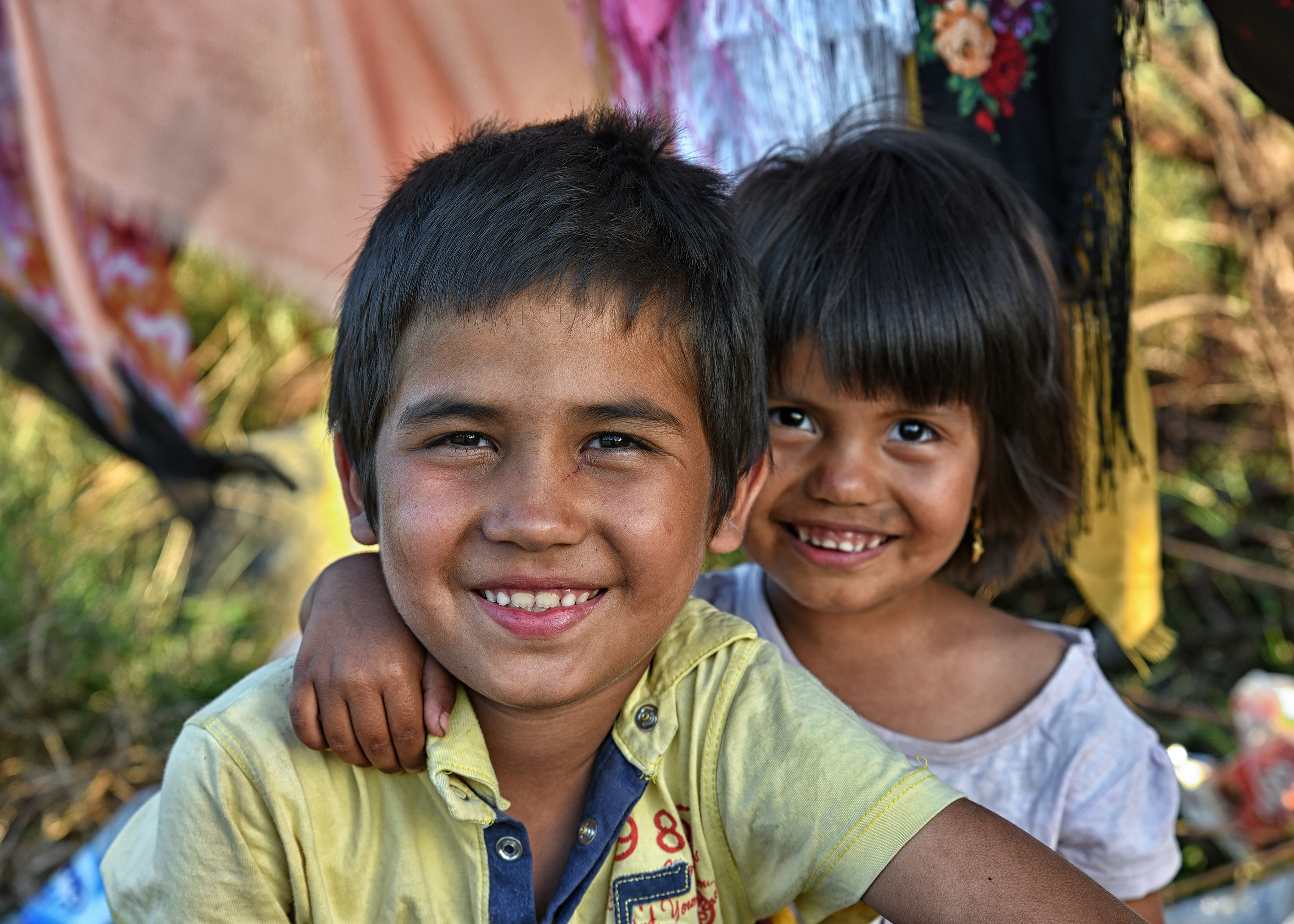 Two smiling children embrace each other joyfully. photo – Free Street ...