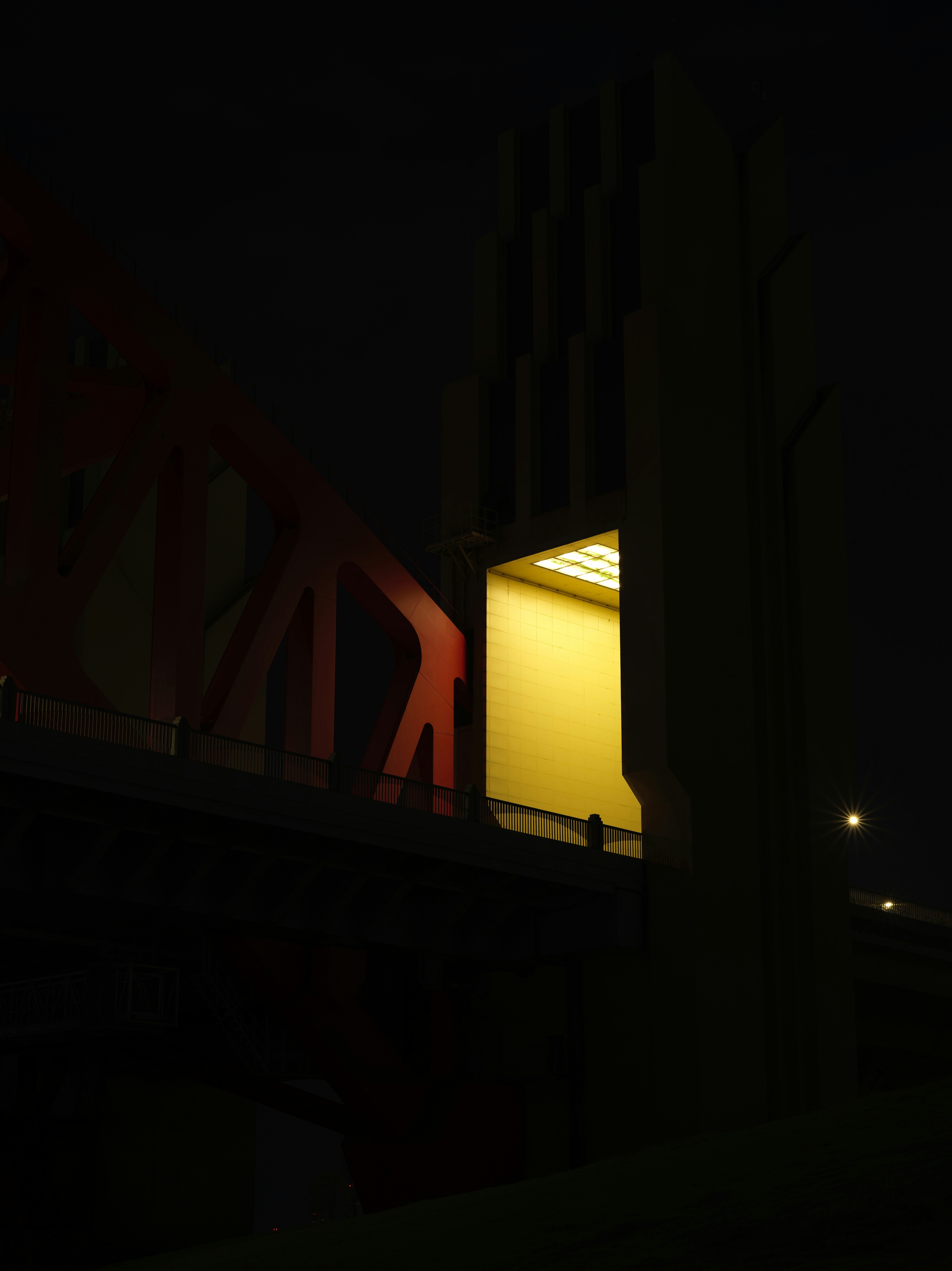 Illuminated Structure Amidst Urban Shadows