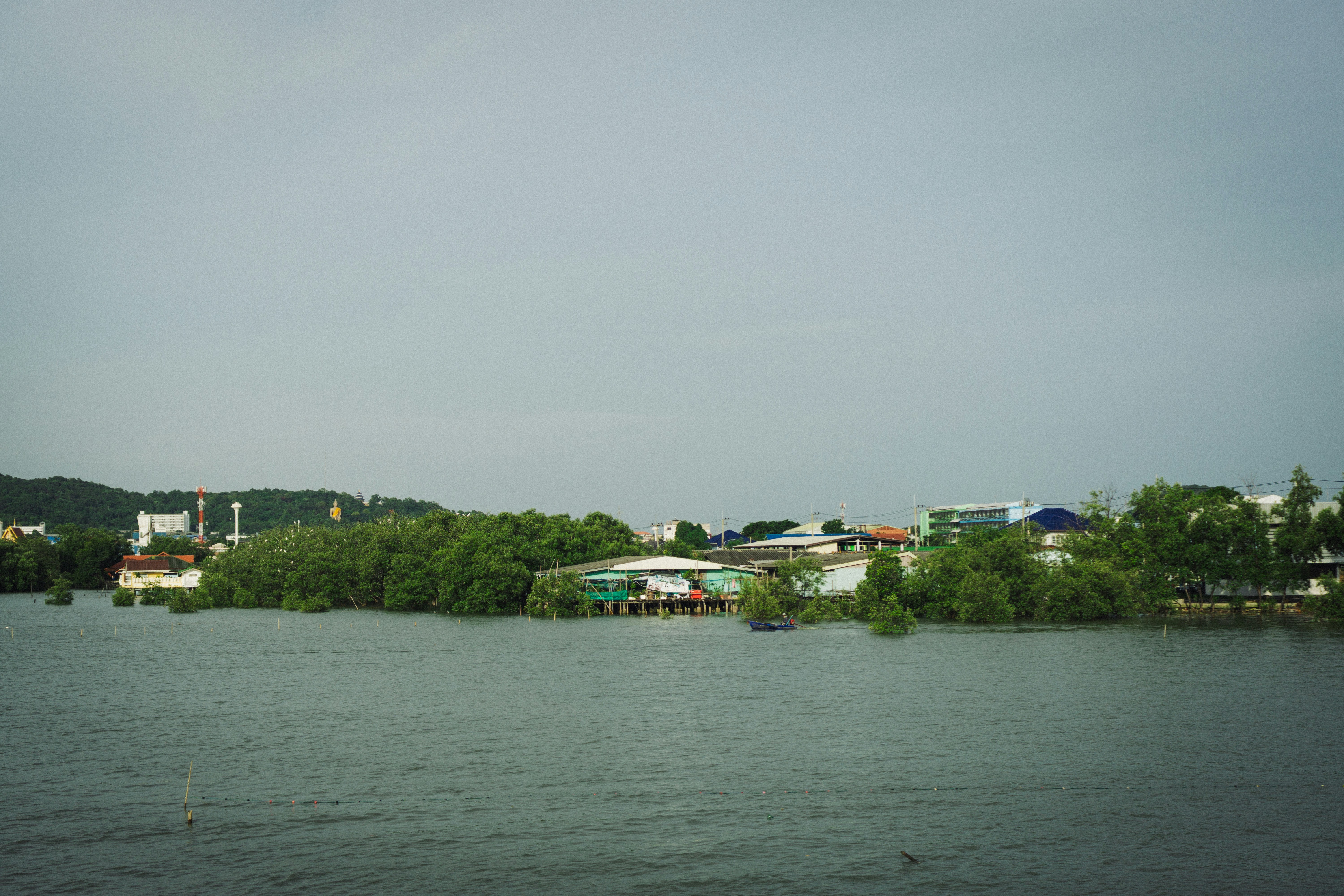 A calm body of water with buildings.