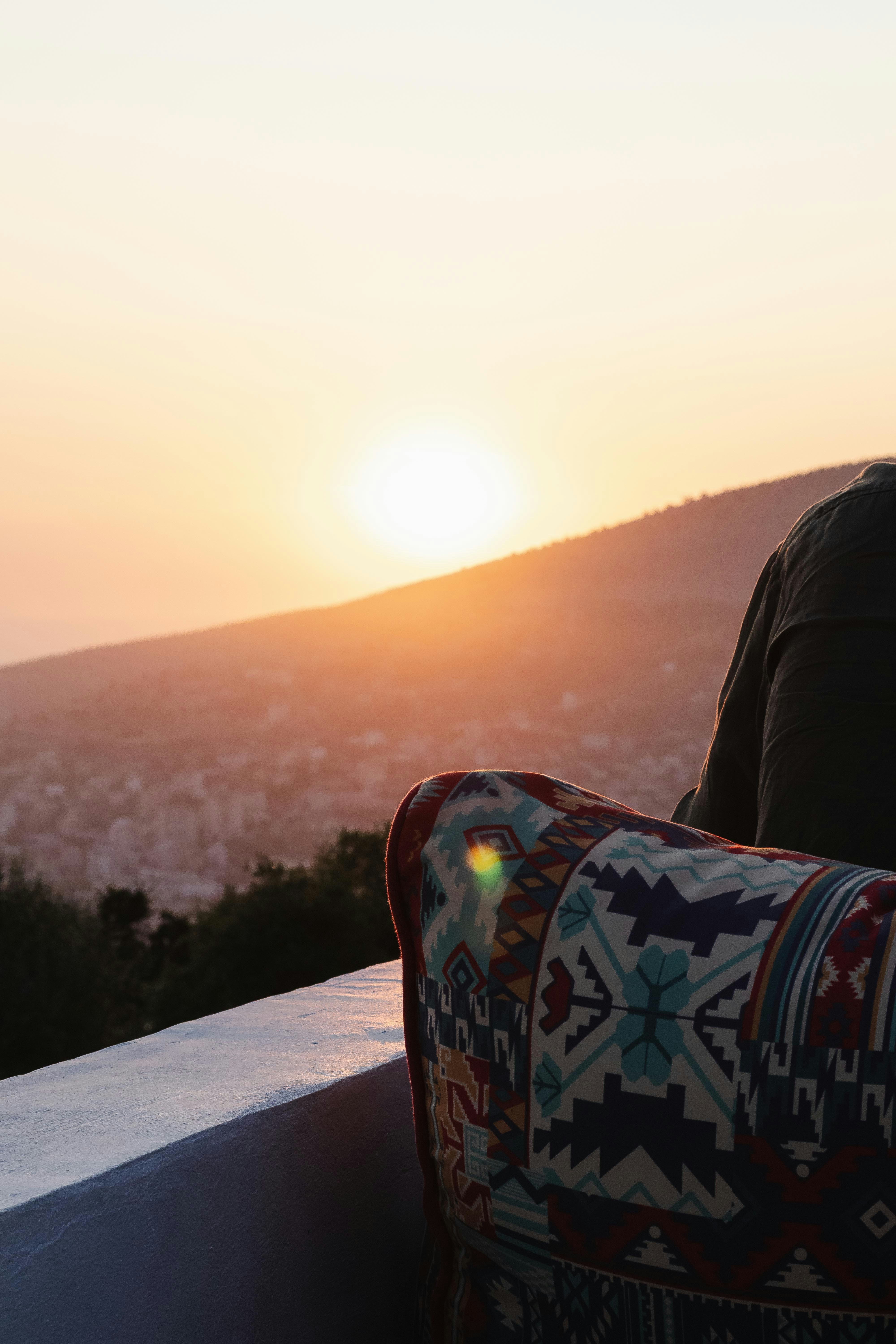 Sunset Bench: Warm Light and Geometric Textile in Quiet Terrace