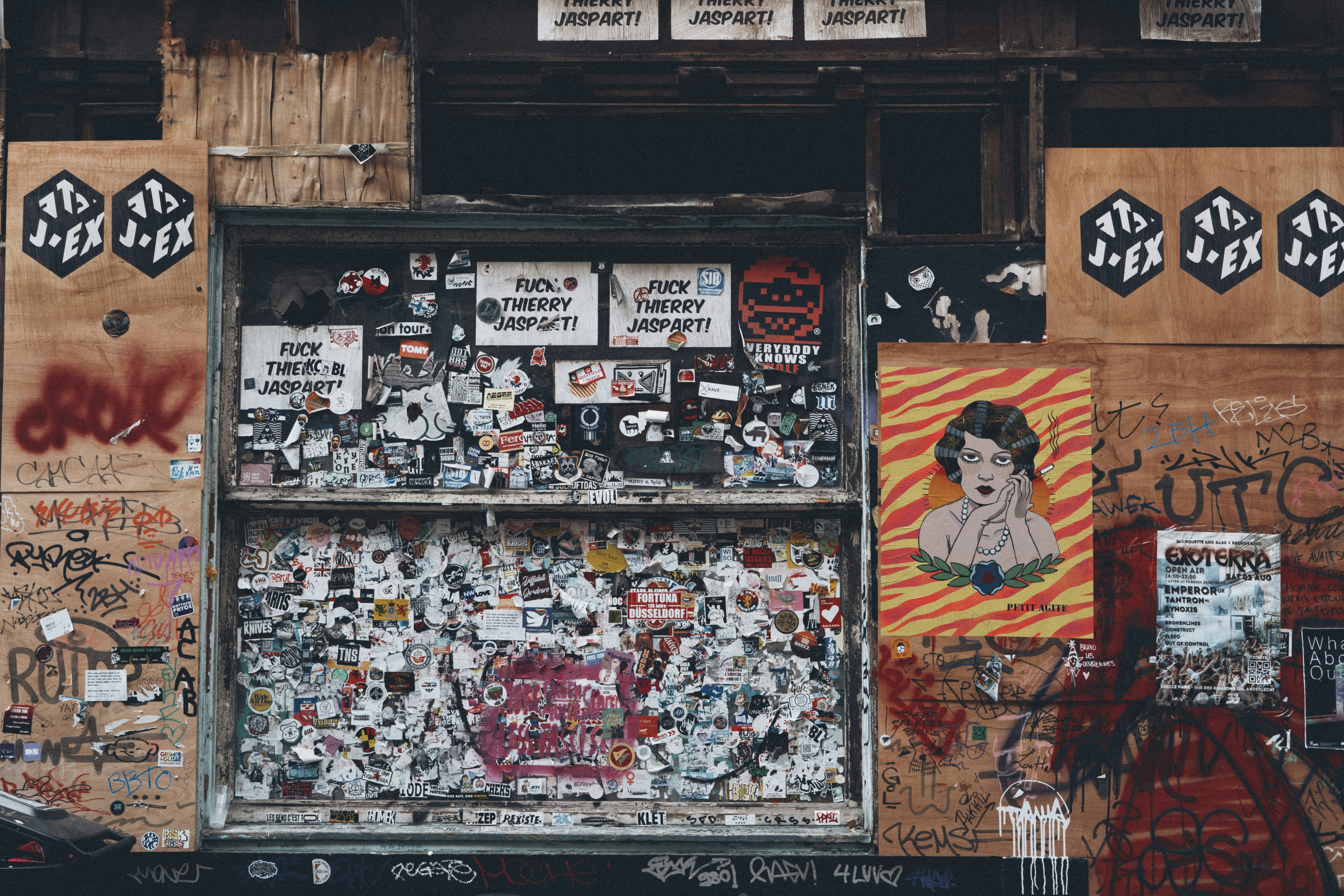 A bulletin board covered in flyers and graffiti. photo – Free Street ...